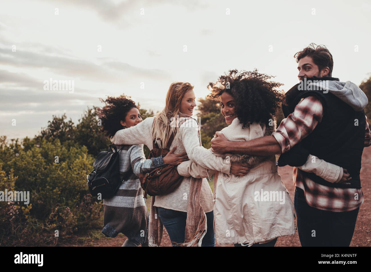 Friends hiking in nature. Group of man and women walking together in ...