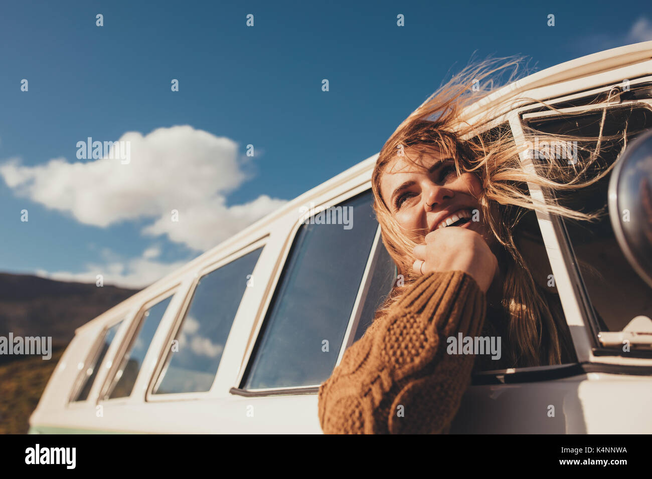 Woman driving a van and enjoying road trip. Laughing young female ...