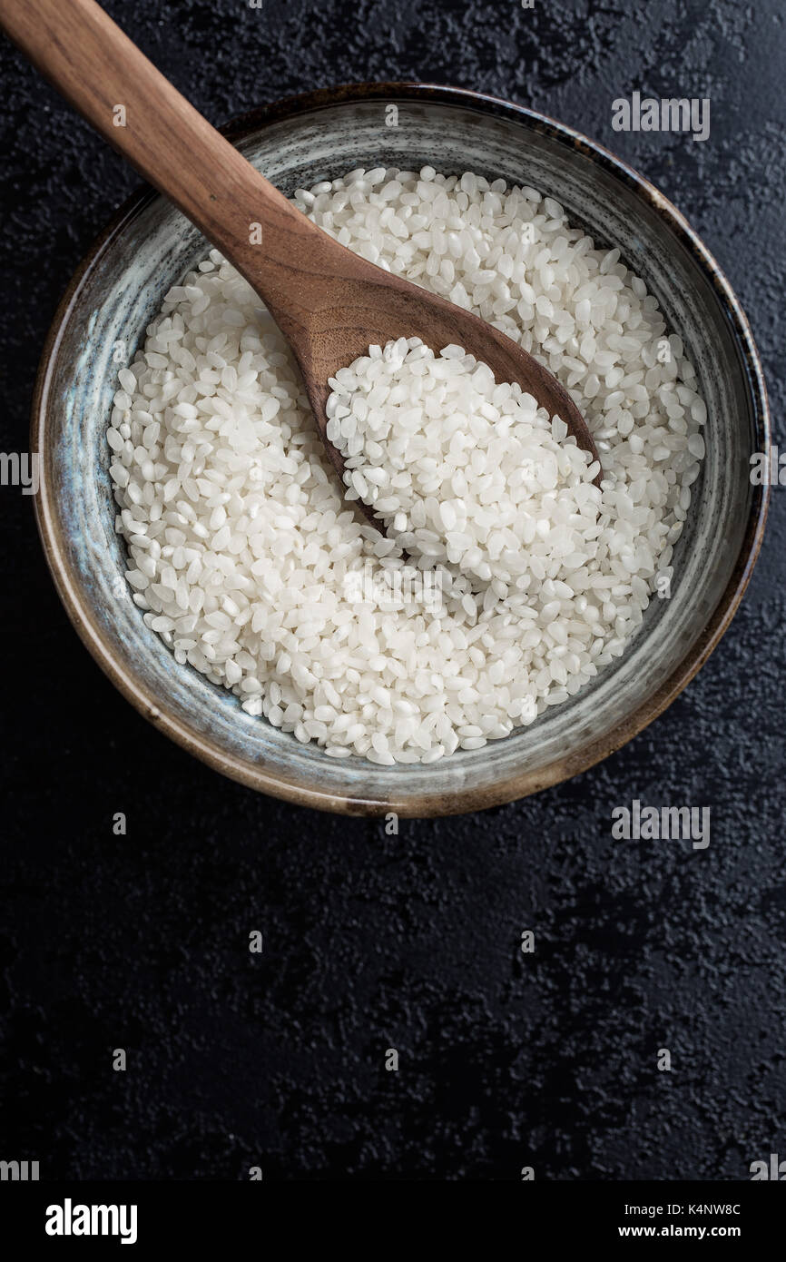 White sushi rice in bowl on black tabel. Top view on rice Stock Photo ...