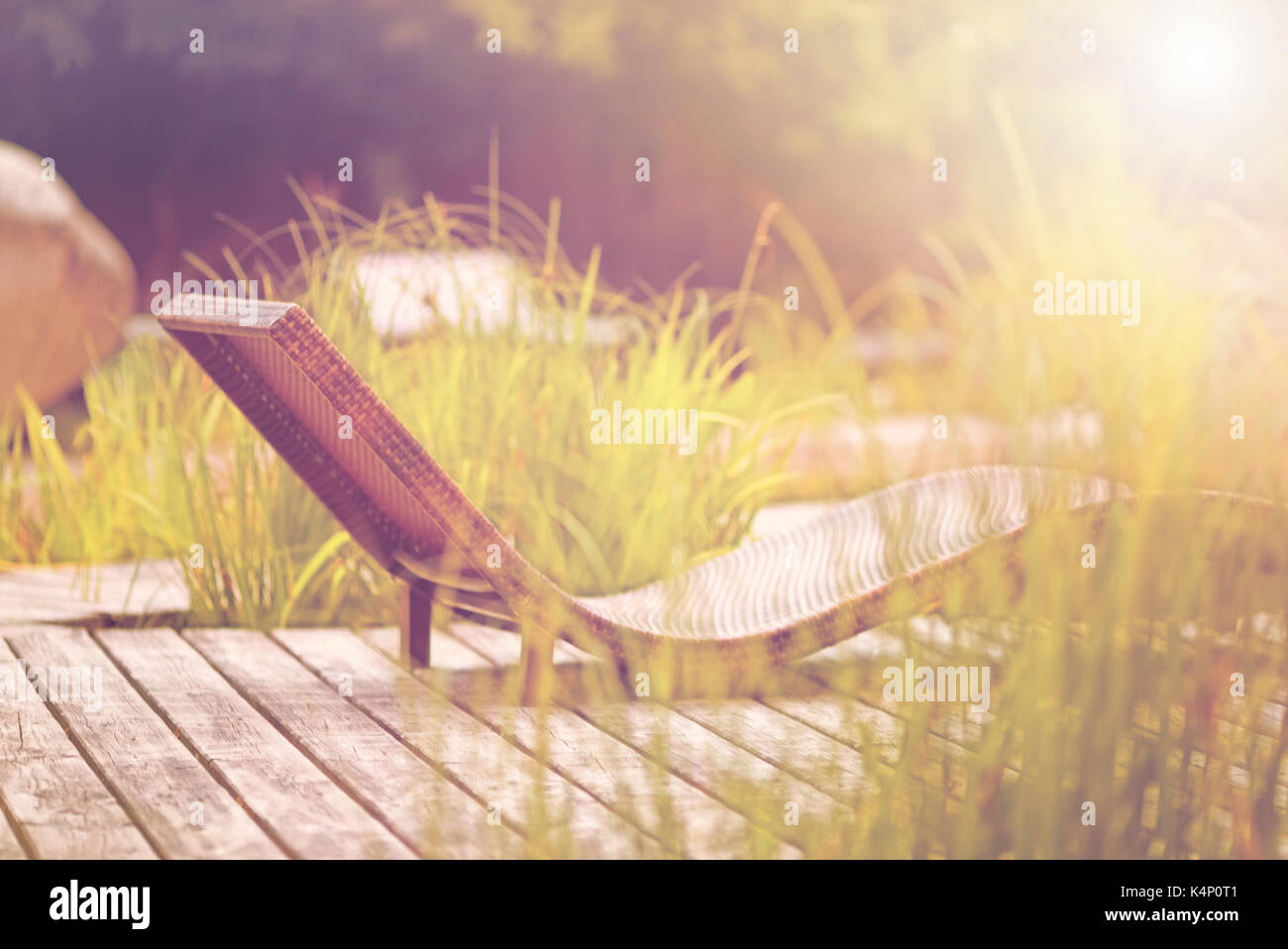 braun beach chair over green nature background, sunny summer outdoor ...