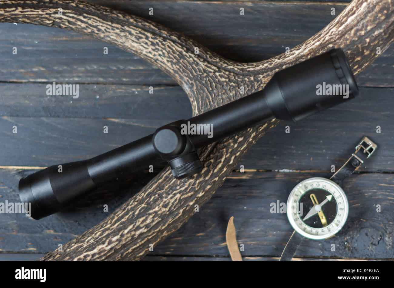 Black optical sight for hunting and a tourist compass Stock Photo - Alamy
