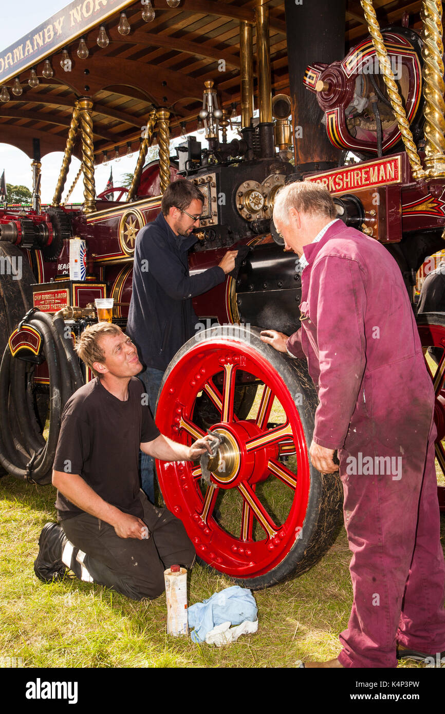 Tree men cleaning and polishing their vintage steam traction engine at ...