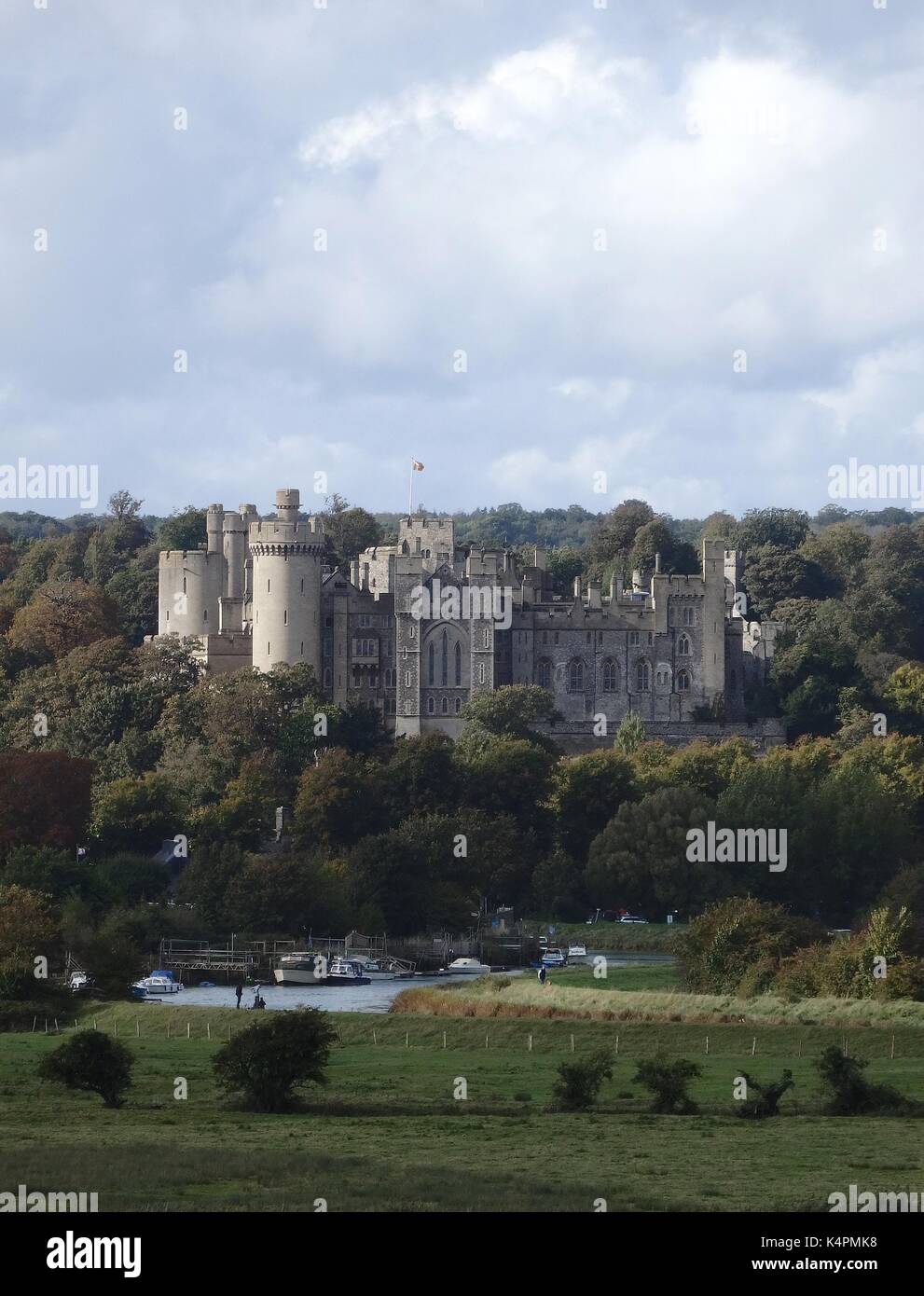 Arundel Castle in West Sussex Exterior with River Arun and boats moored ...