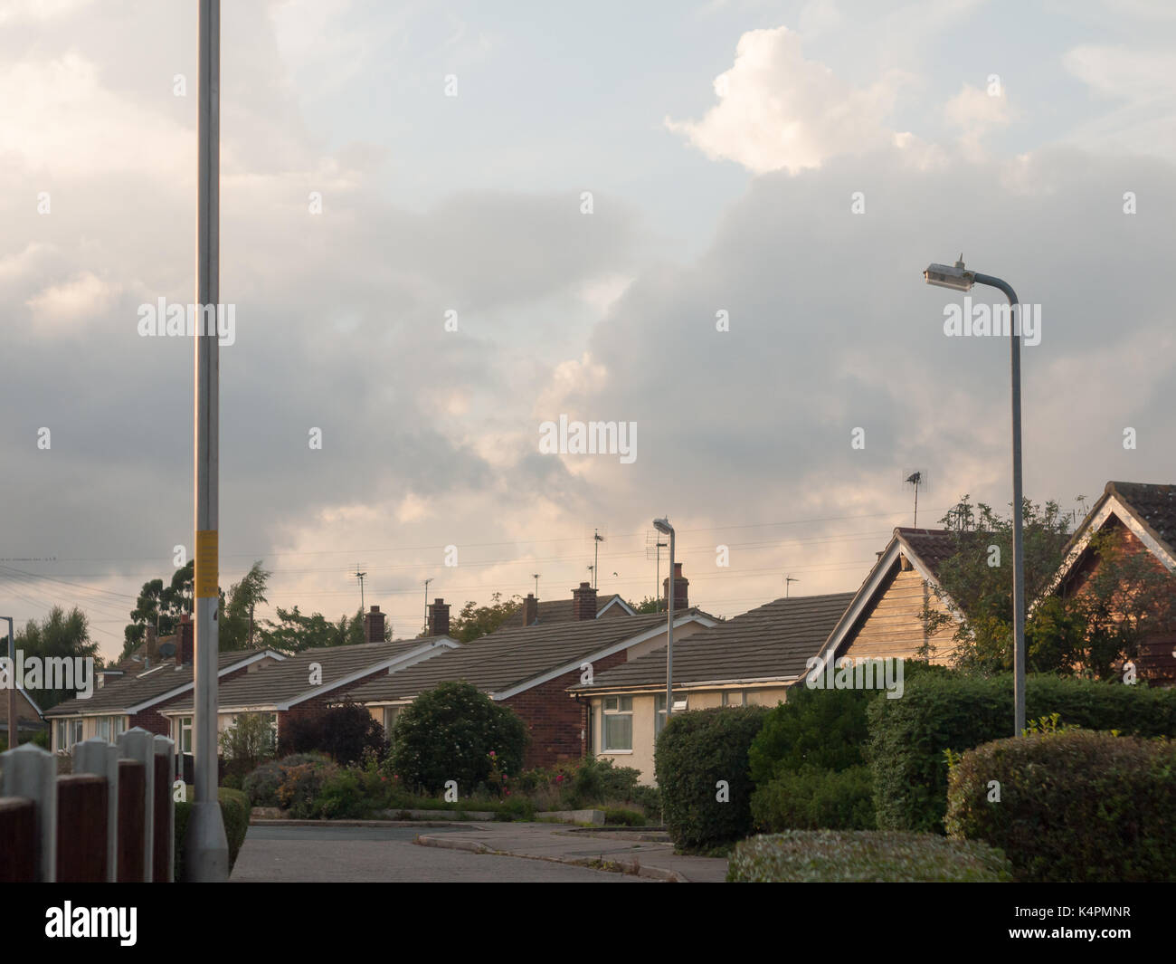 dramatic cloudy white skies above village scene in england during ...