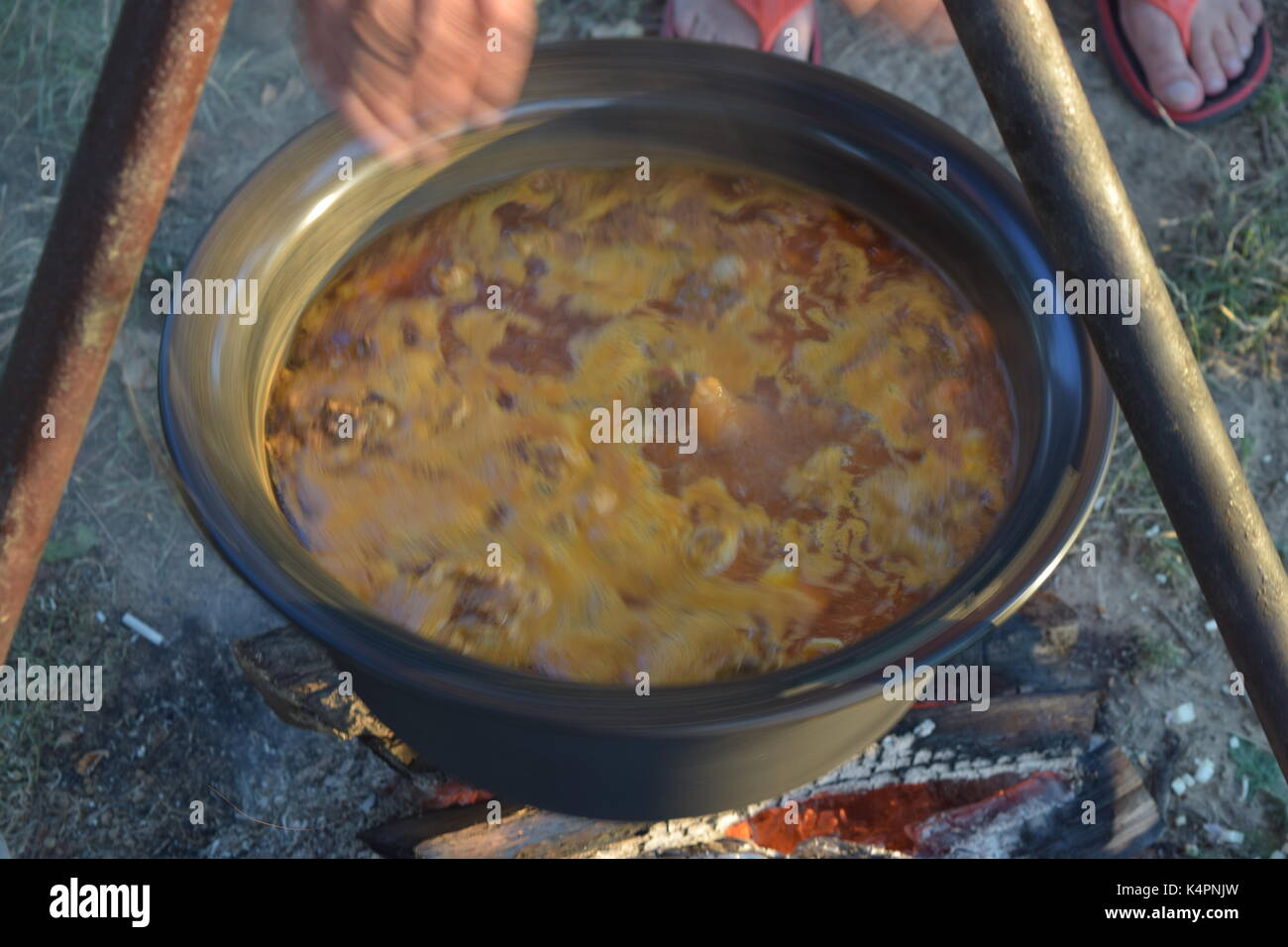Juicy bubbling stew in a large pot cooking outdoors Stock Photo - Alamy
