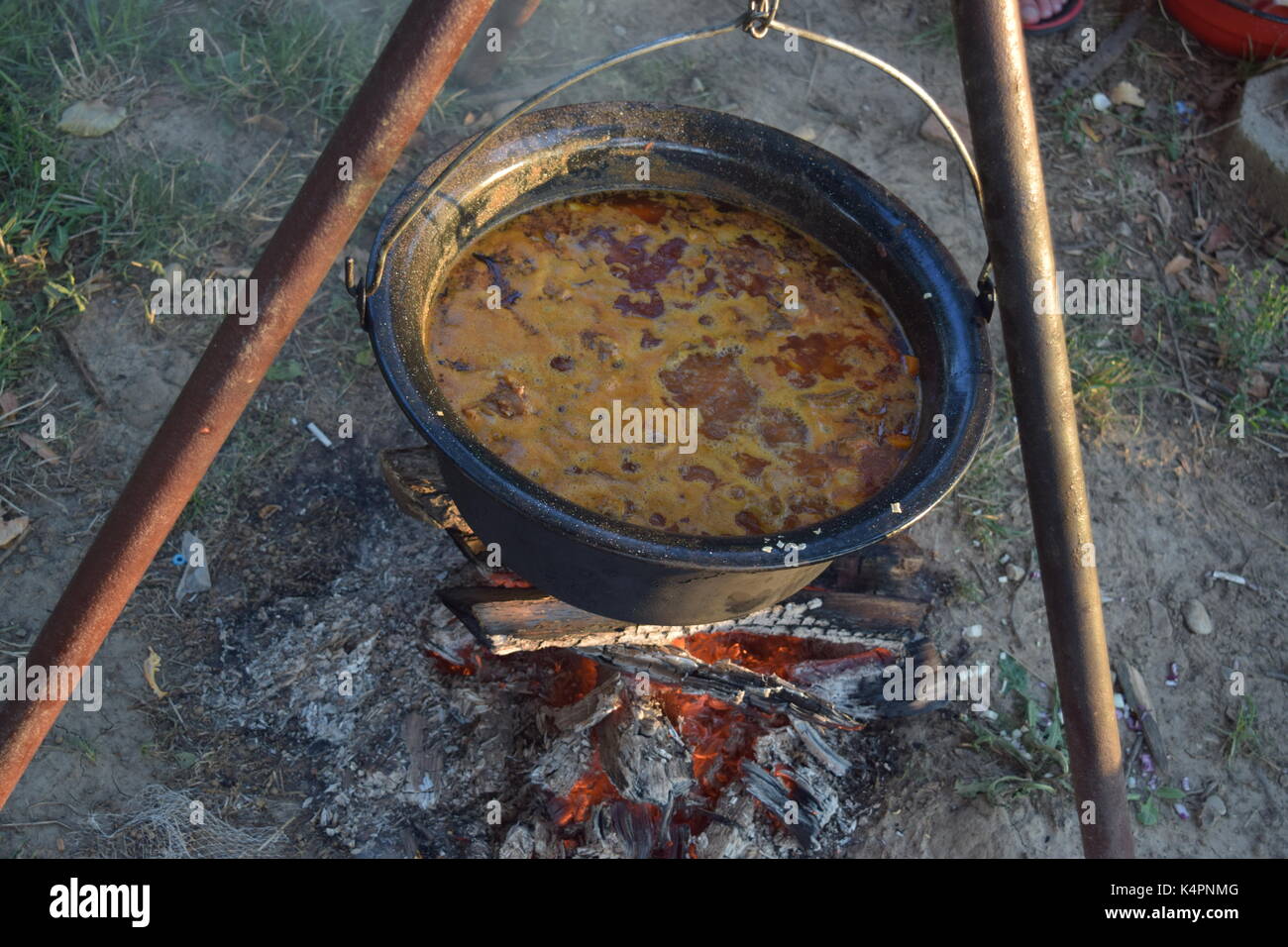 Juicy bubbling stew in a large pot cooking outdoors Stock Photo - Alamy