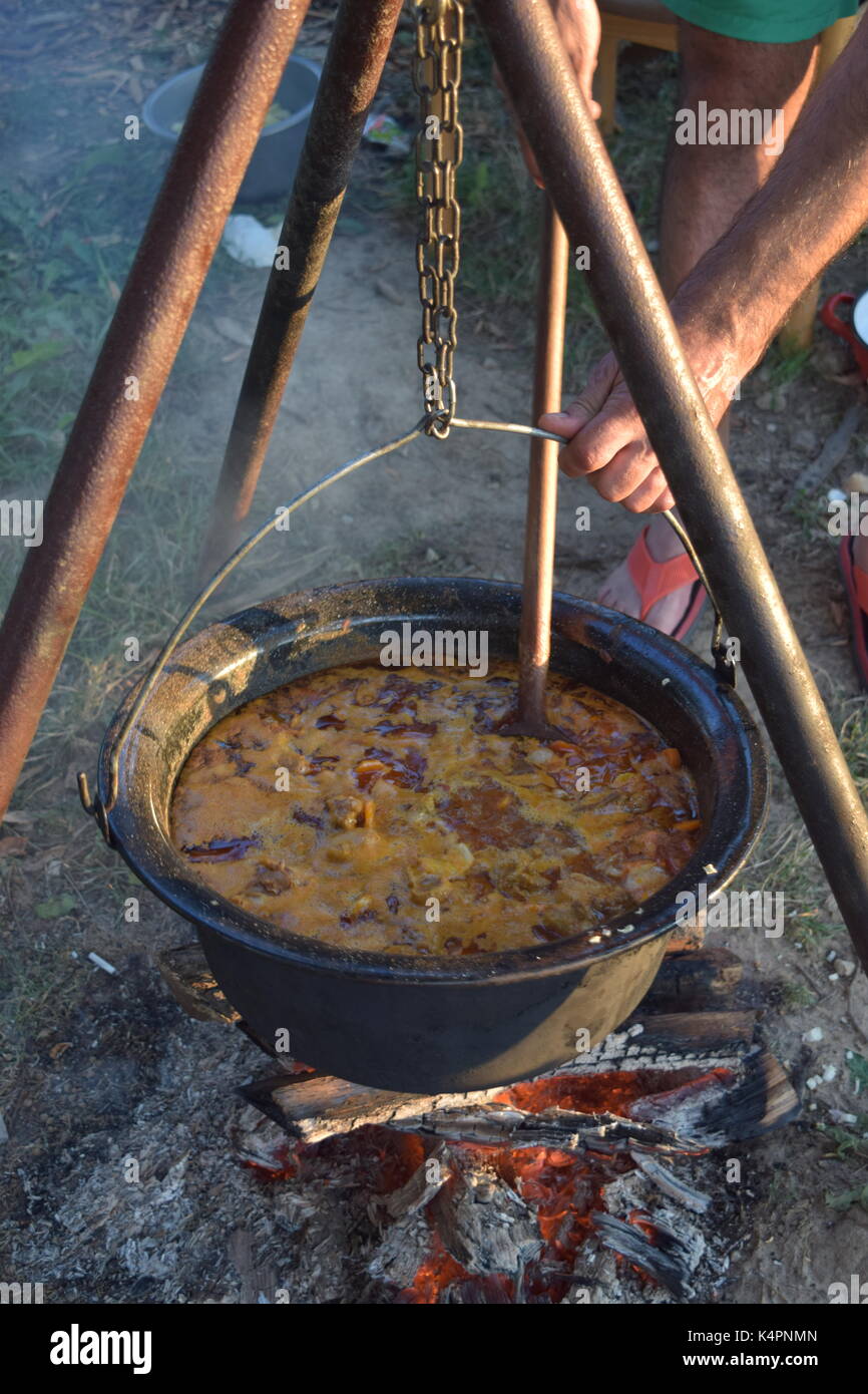 Juicy bubbling stew in a large pot cooking outdoors Stock Photo - Alamy