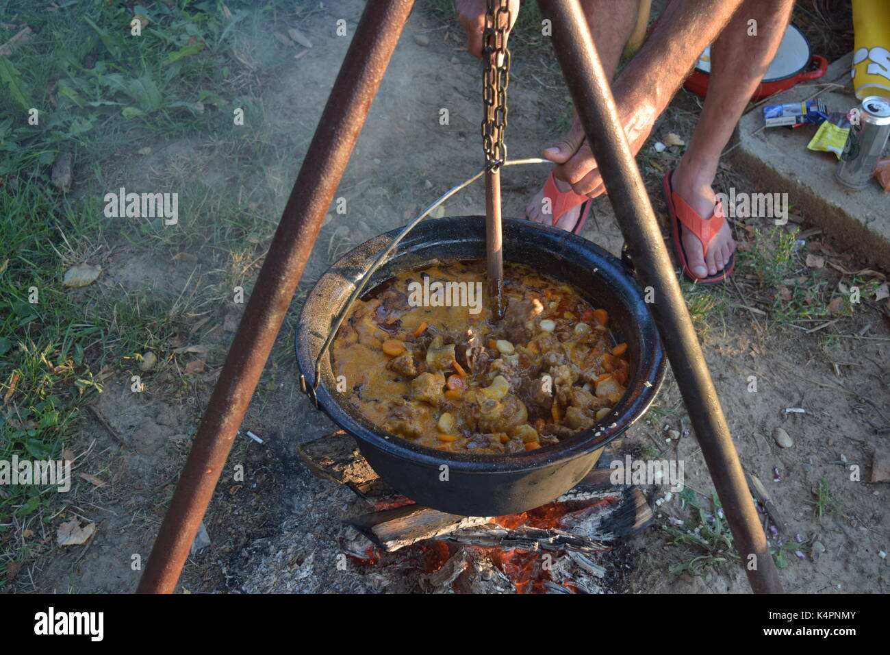 Juicy bubbling stew in a large pot cooking outdoors Stock Photo - Alamy