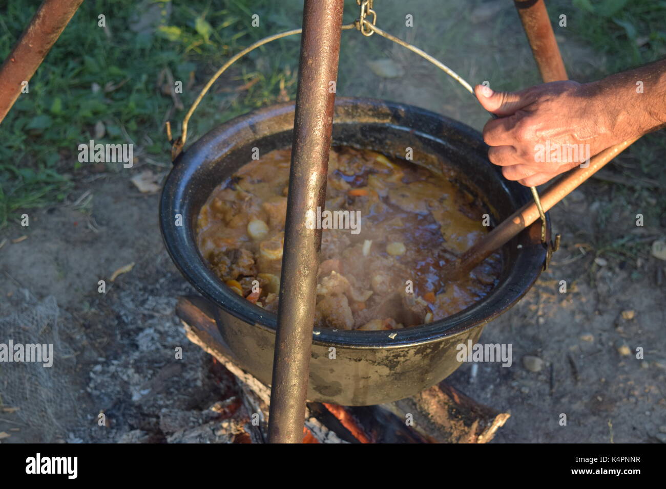 Juicy bubbling stew in a large pot cooking outdoors Stock Photo - Alamy
