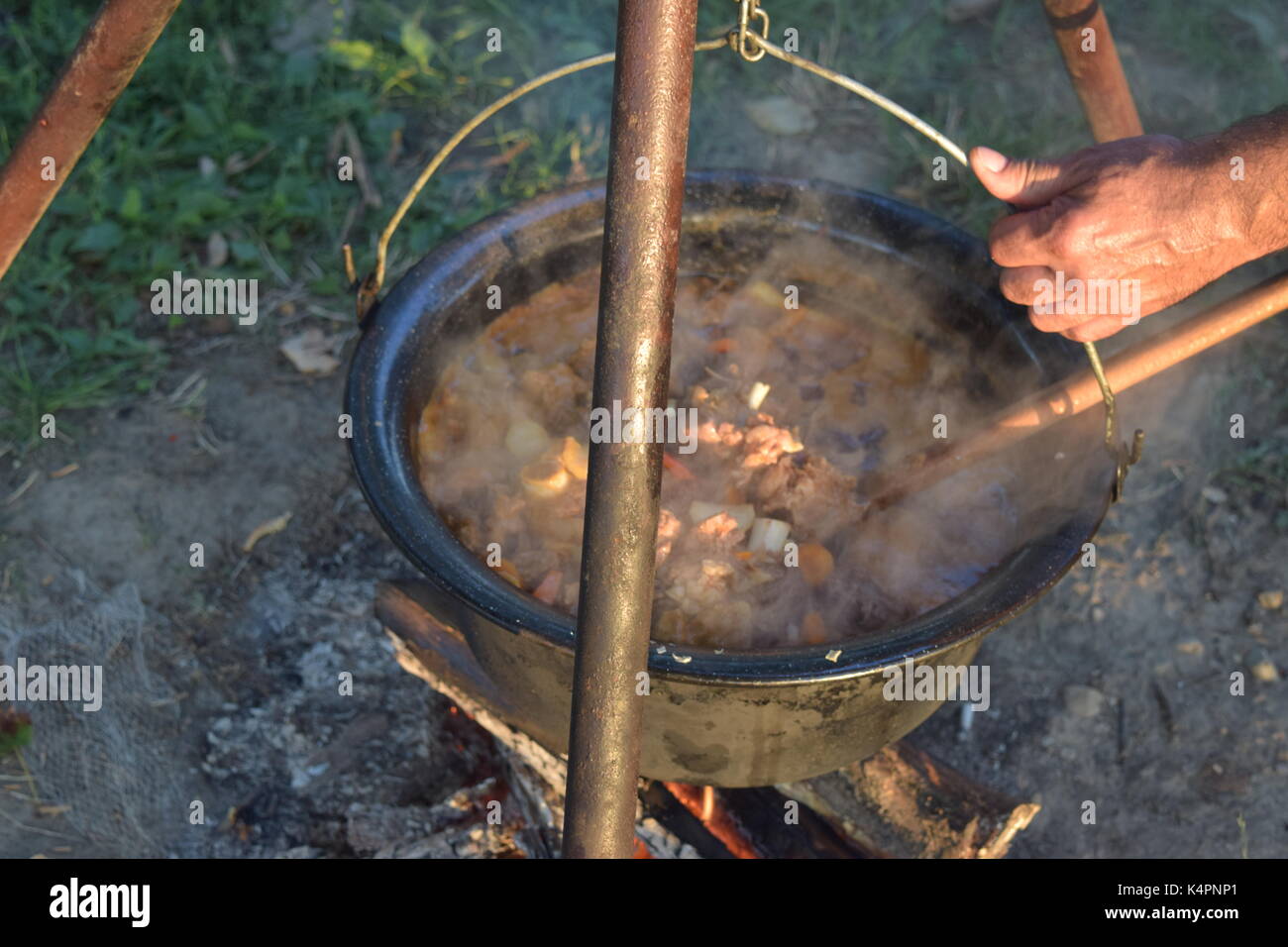 Juicy bubbling stew in a large pot cooking outdoors Stock Photo - Alamy