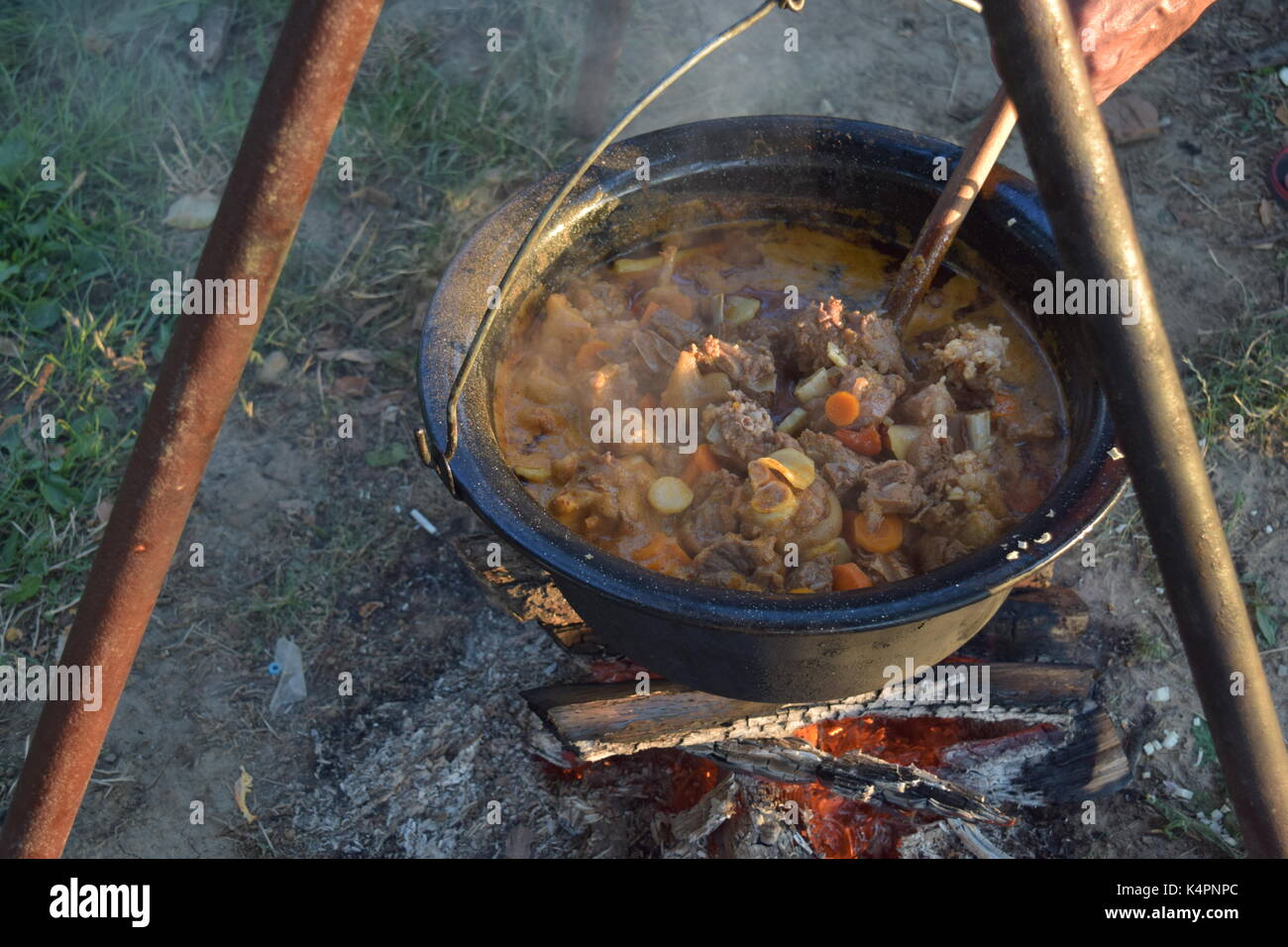 Juicy bubbling stew in a large pot cooking outdoors Stock Photo - Alamy