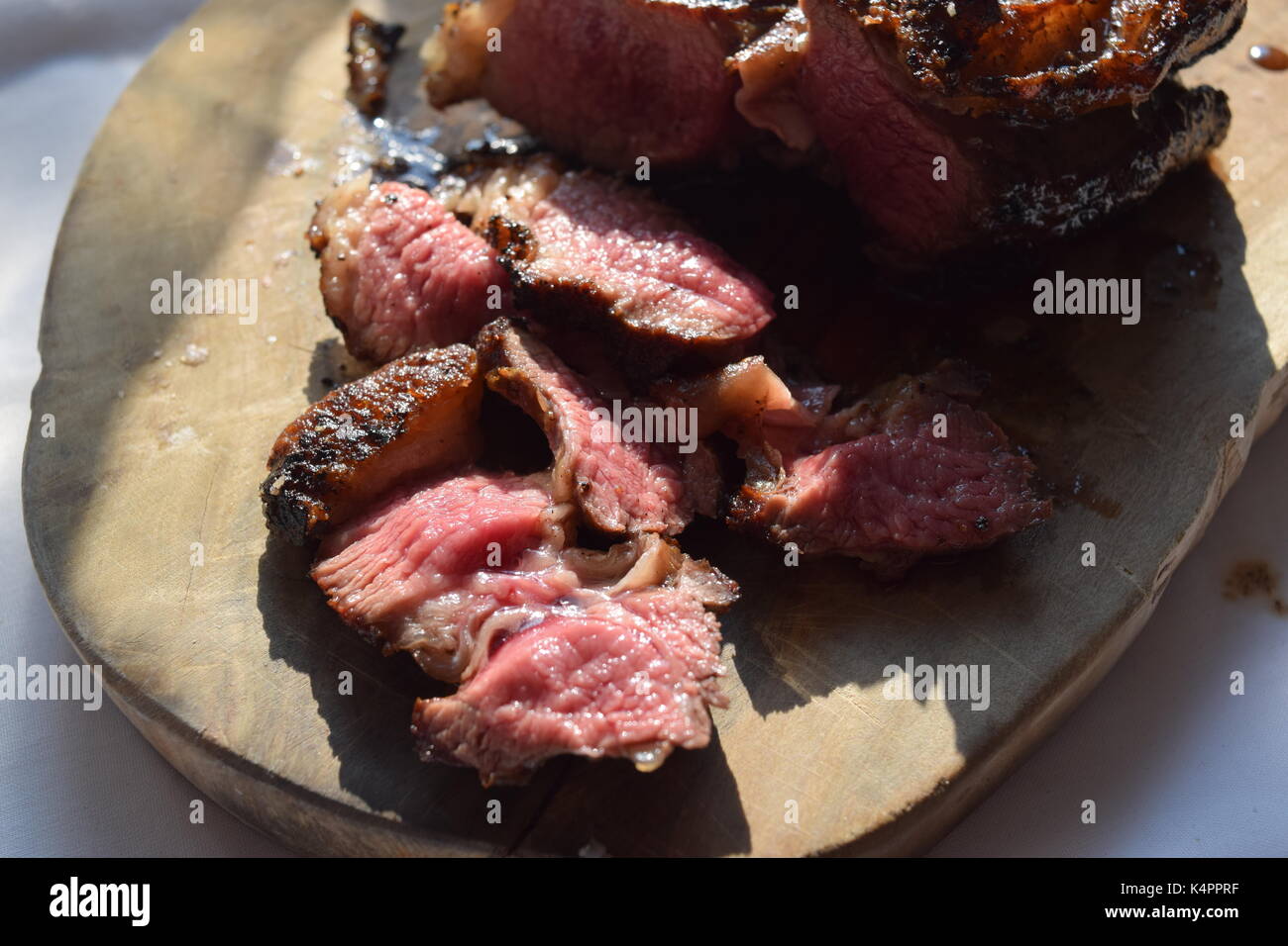 Succulent pieces of rare beef cooking Stock Photo - Alamy