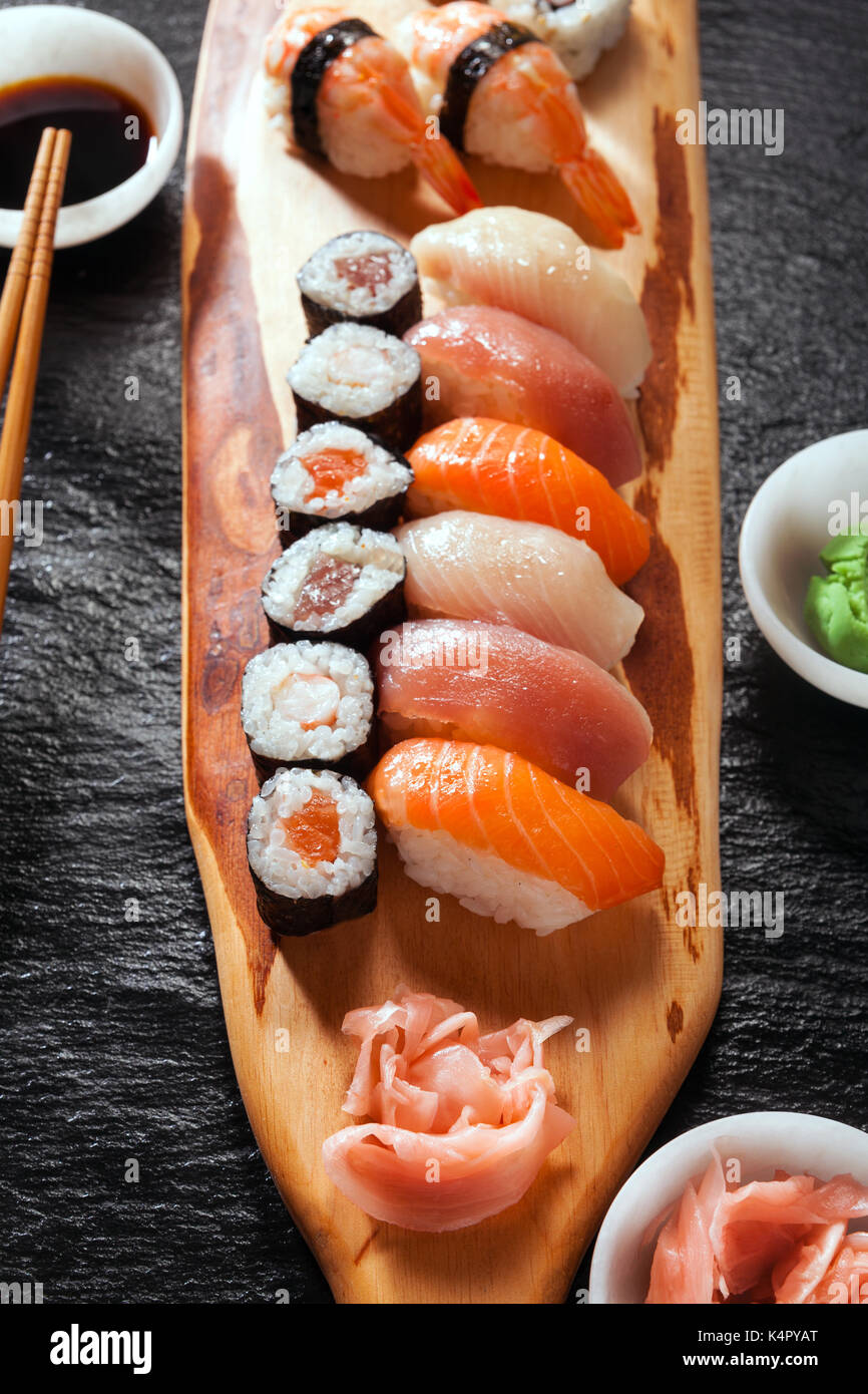 Sushi Set gunkan, nigiri and rolls served on black stone background ...