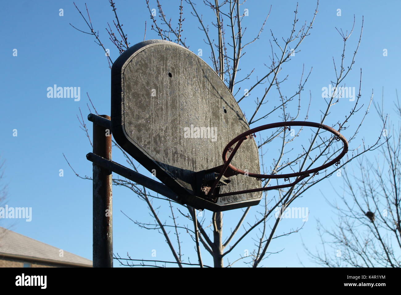 Basketball hoop with morning spring frost and blue sky Stock Photo - Alamy