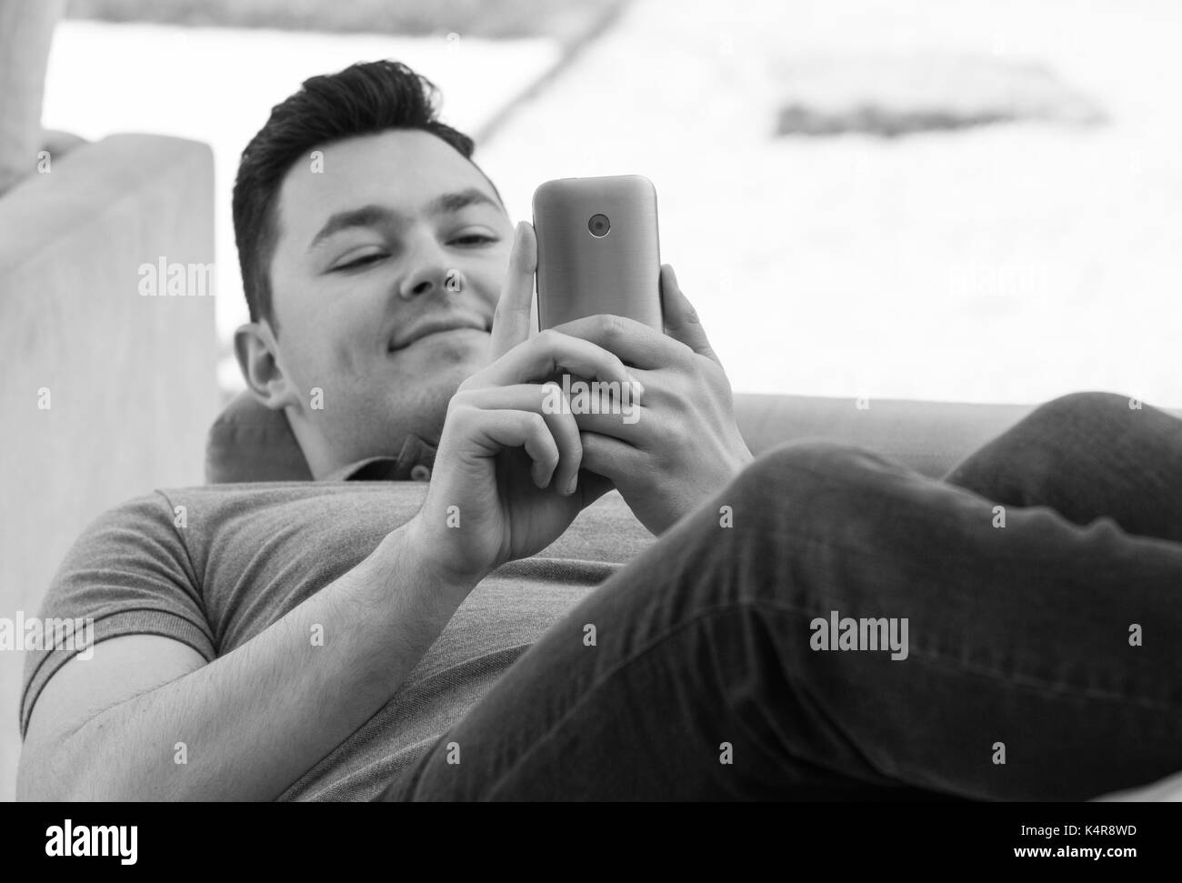 Smiling man using cell phone Black and White Stock Photos & Images - Alamy