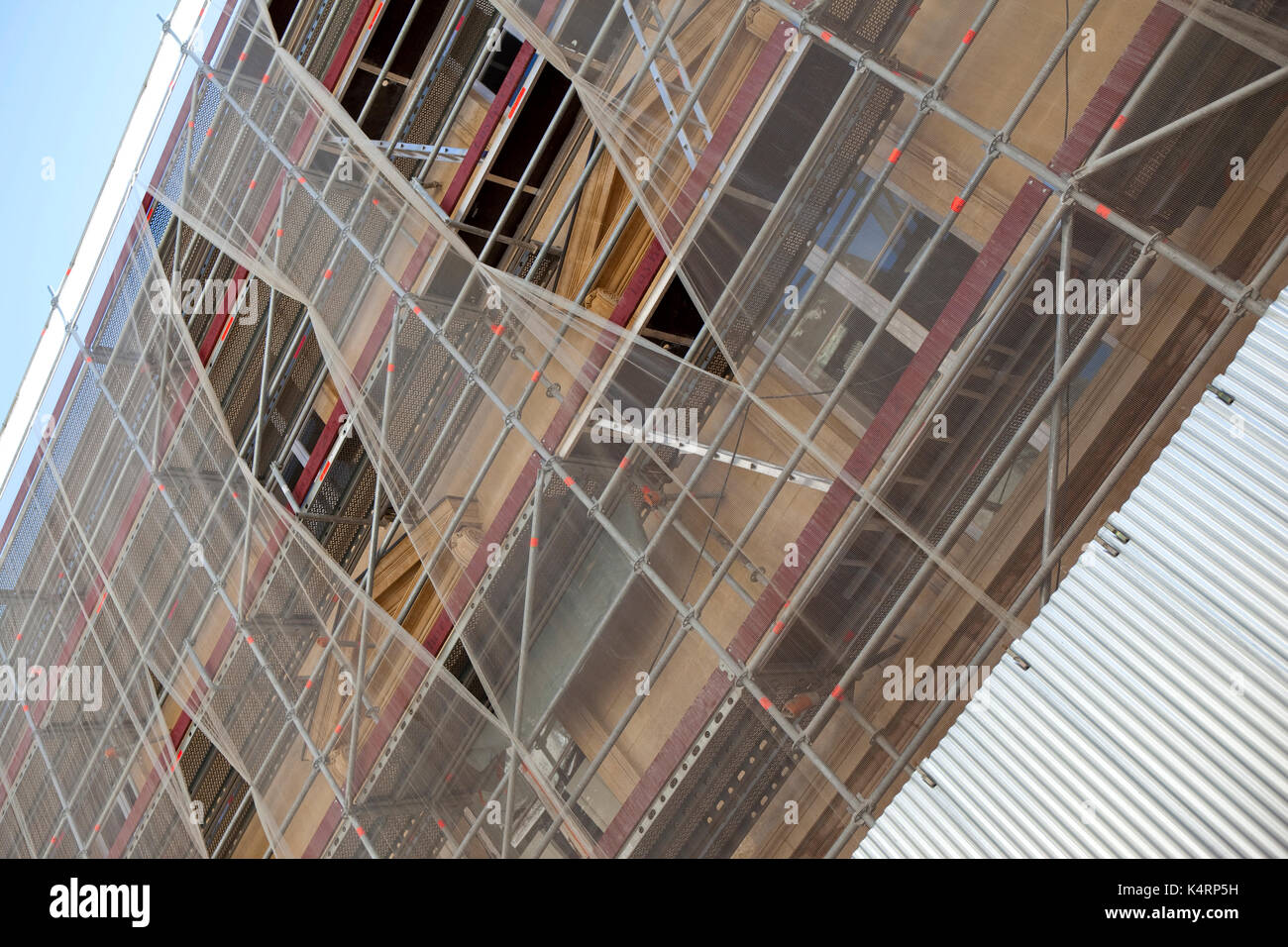 Scaffolding and safety net on a renovation site Stock Photo - Alamy