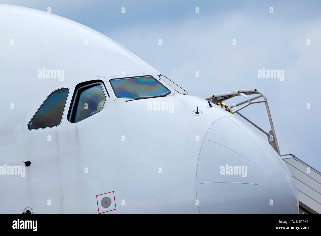 Cockpit and fuselage of an airliner at an airport Stock Photo - Alamy
