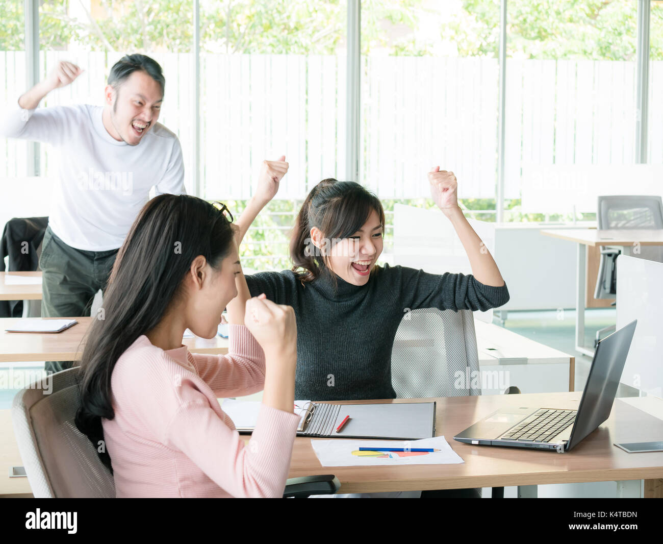 Businessman cheering desk in office hi-res stock photography and images ...