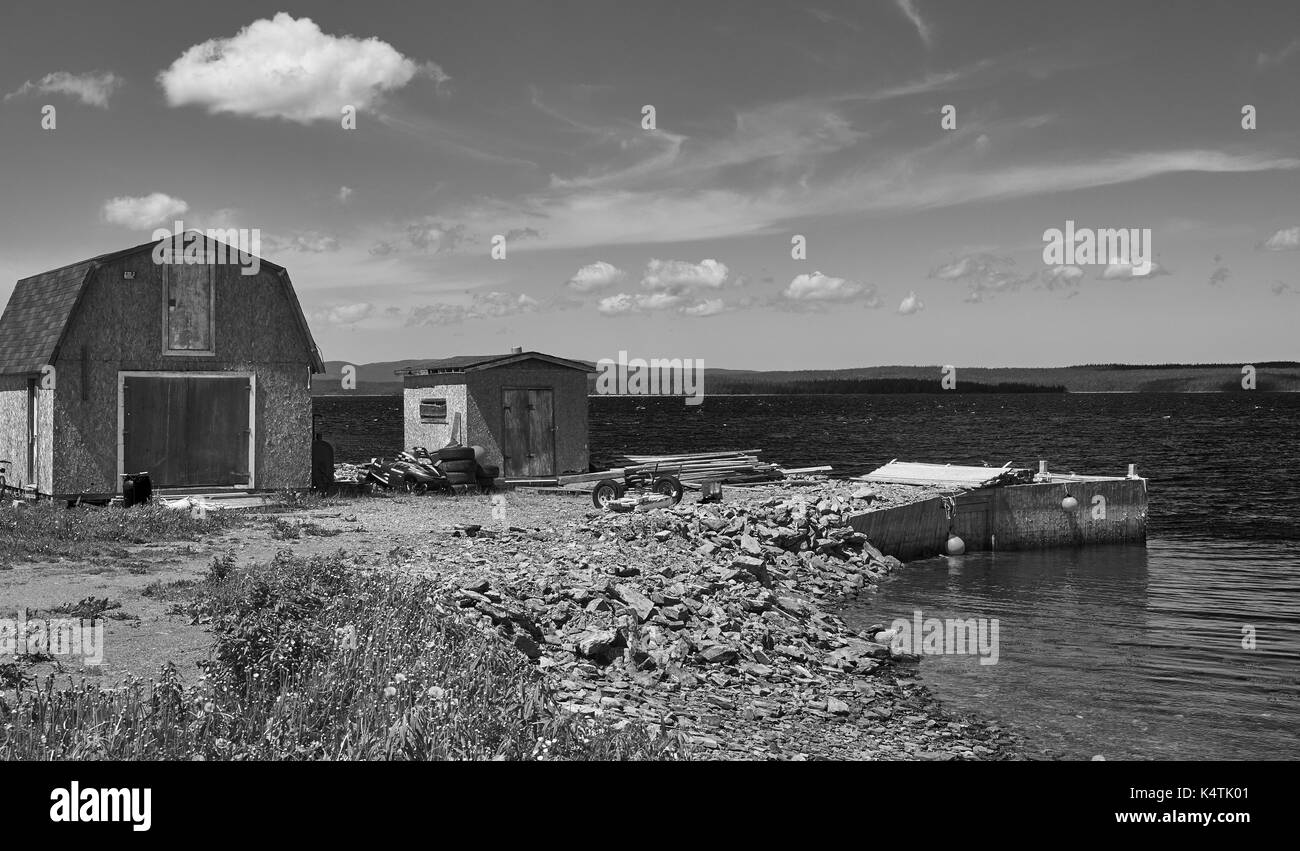 Rustic waterfront cabins and small jetty, Great Northern Peninsula ...