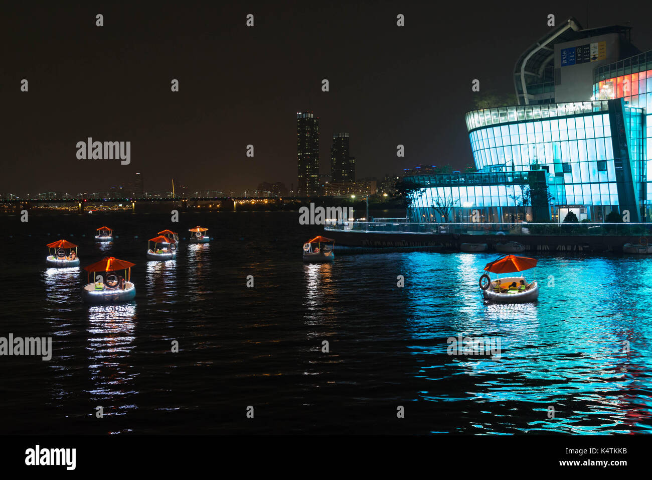 After dark, people enjoy taking out floats on Han river at Sebitseom ...