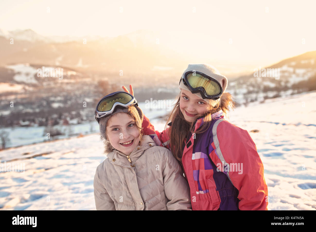 Happy friends have fun on the snow Stock Photo - Alamy