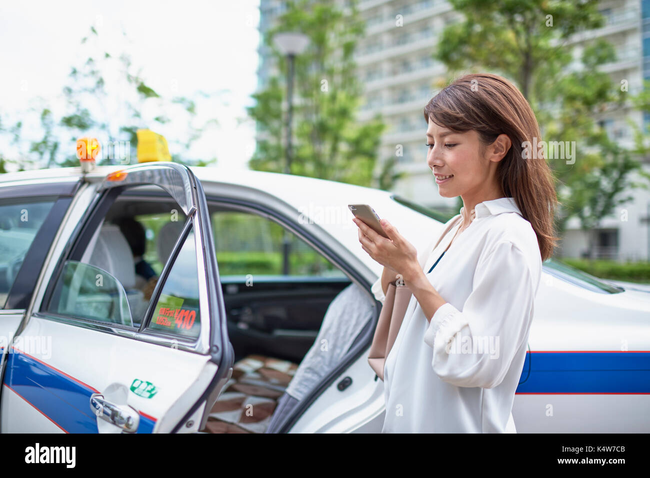 Young Japanese woman riding a taxi downtown Tokyo, Japan Stock Photo ...