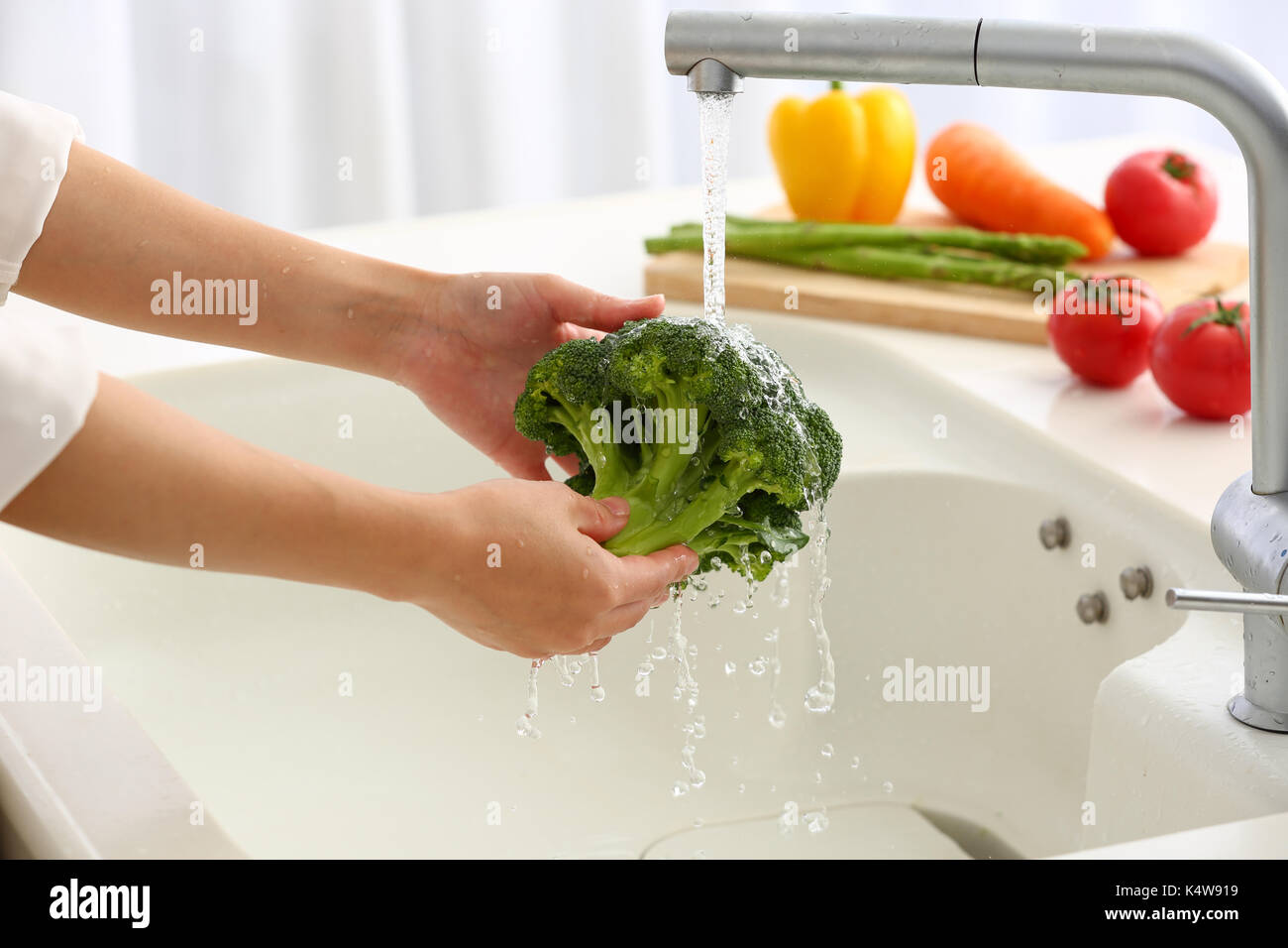 Japanese woman washing vegetables in the kitchen Stock Photo - Alamy