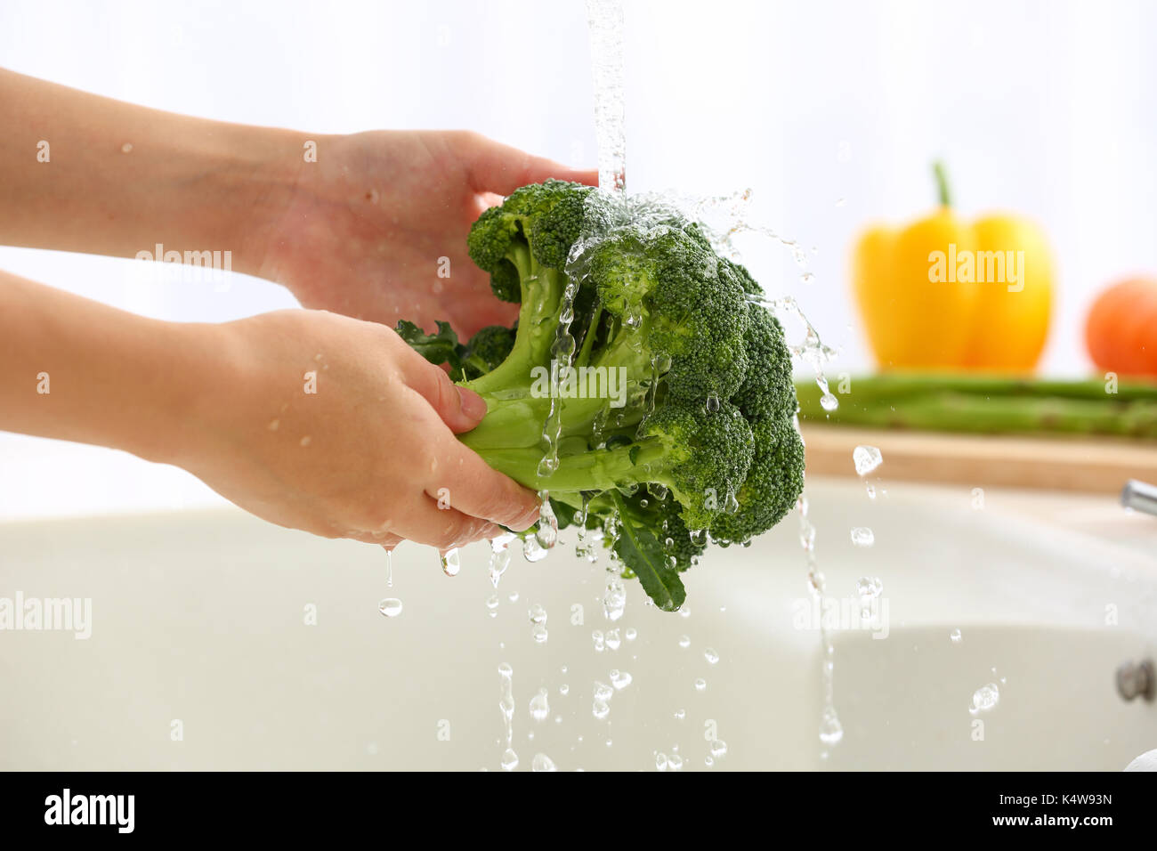 Japanese woman washing vegetables in the kitchen Stock Photo - Alamy