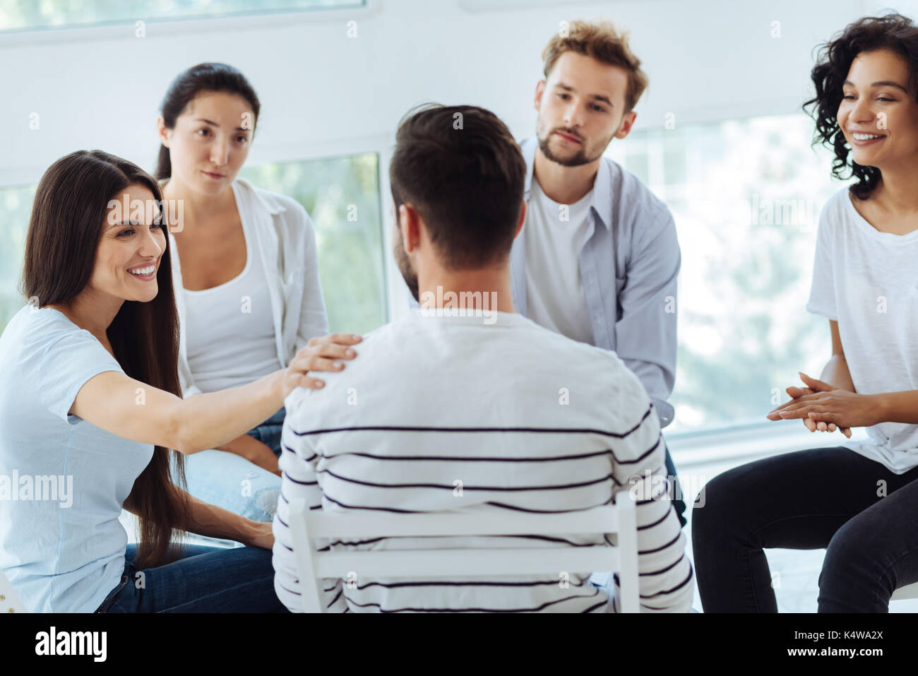Cheerful nice people supporting each other Stock Photo - Alamy