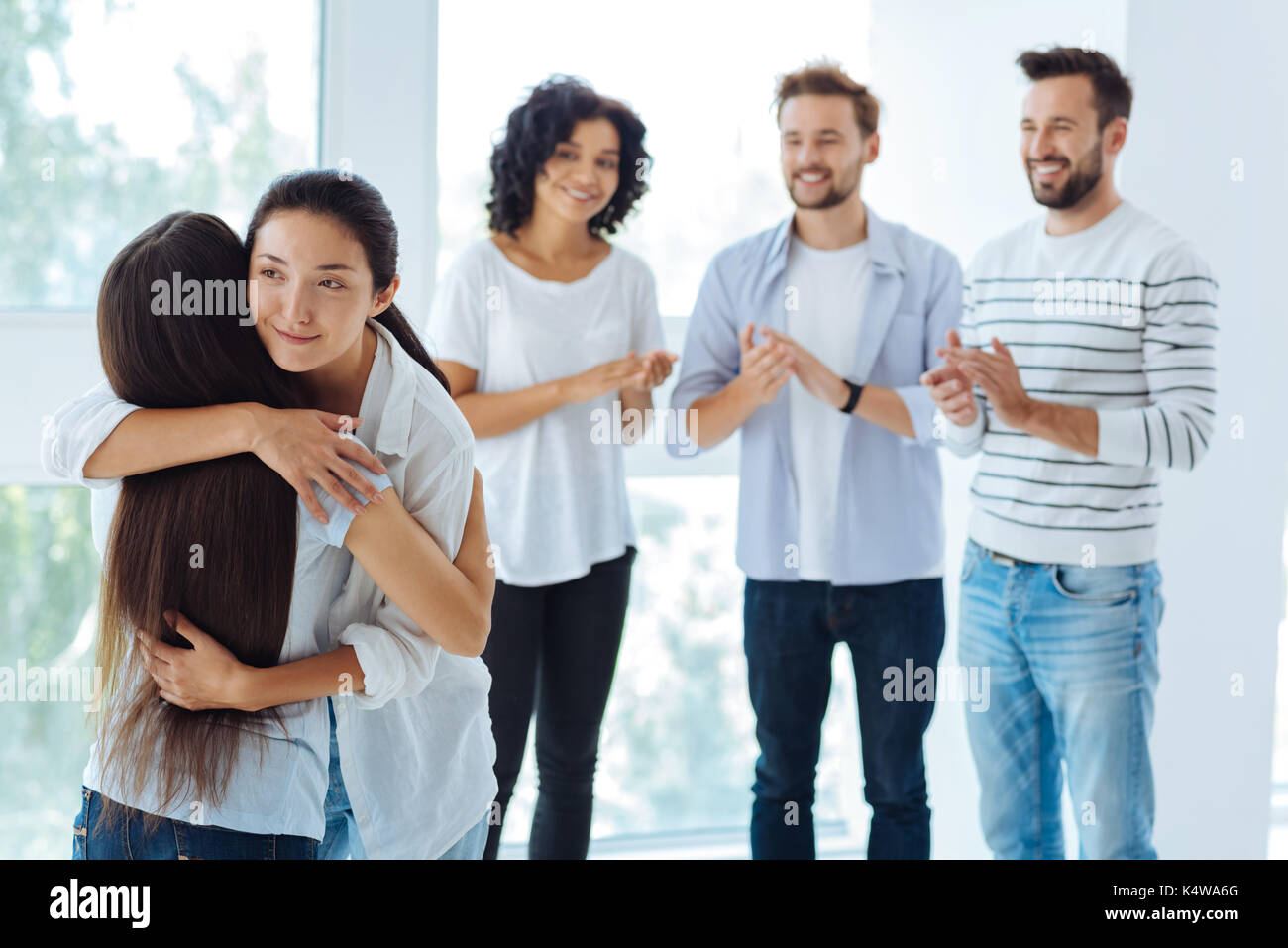Friendly group people hugging hi-res stock photography and images - Alamy