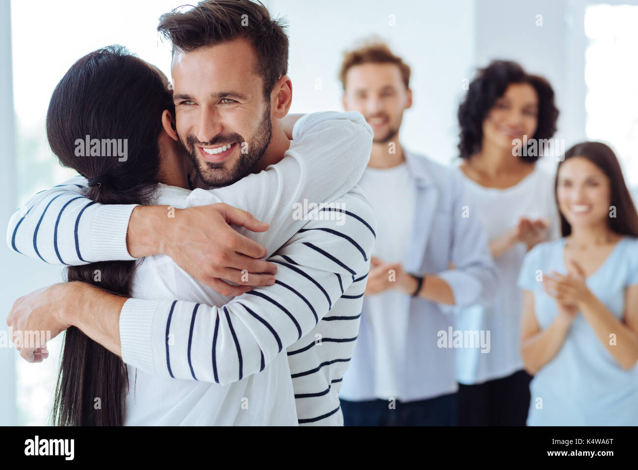 Positive happy people hugging each other Stock Photo - Alamy
