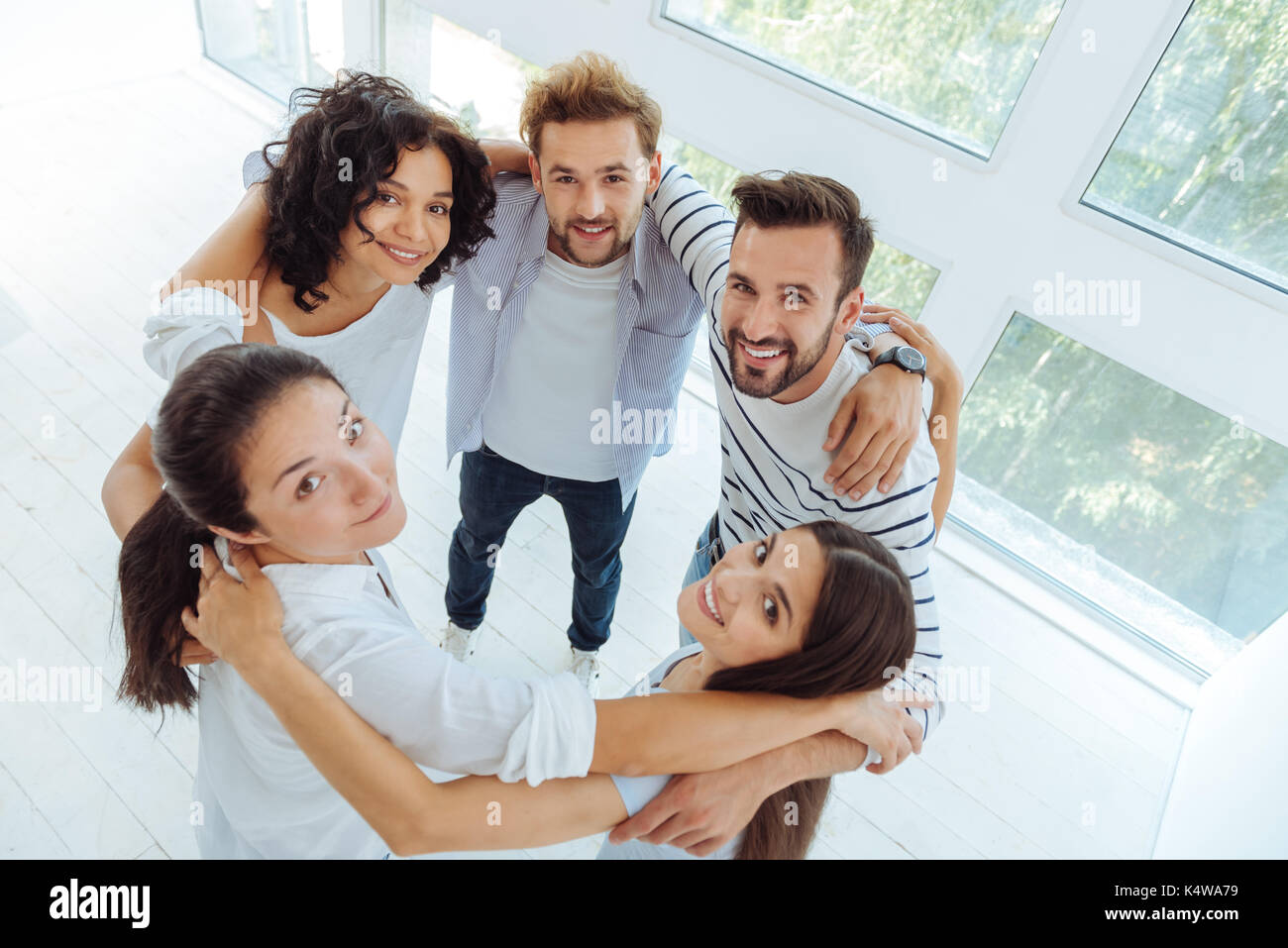 Happy delighted people looking at you Stock Photo - Alamy