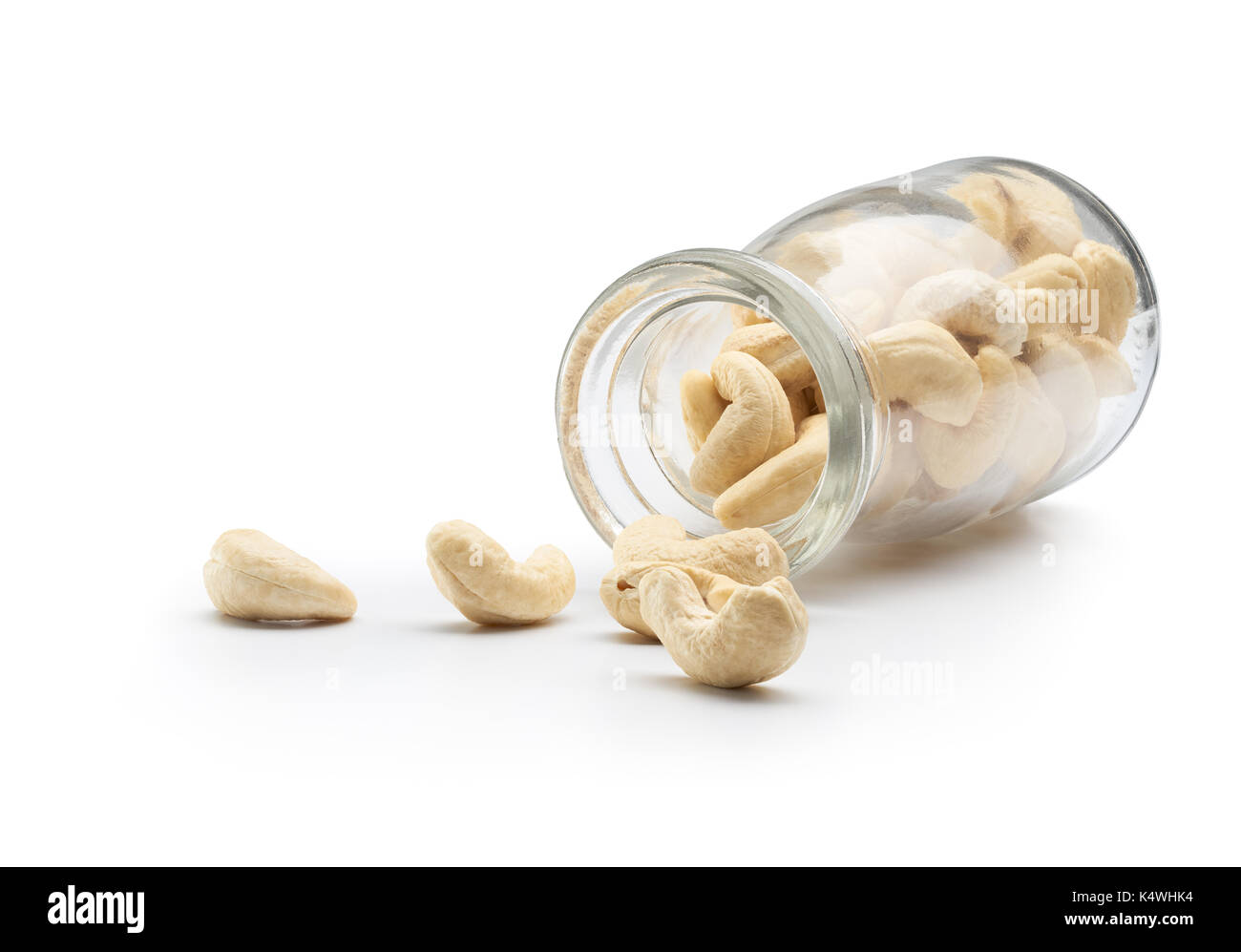 Cashew Nuts pouring out from bottle isolated on white Stock Photo - Alamy
