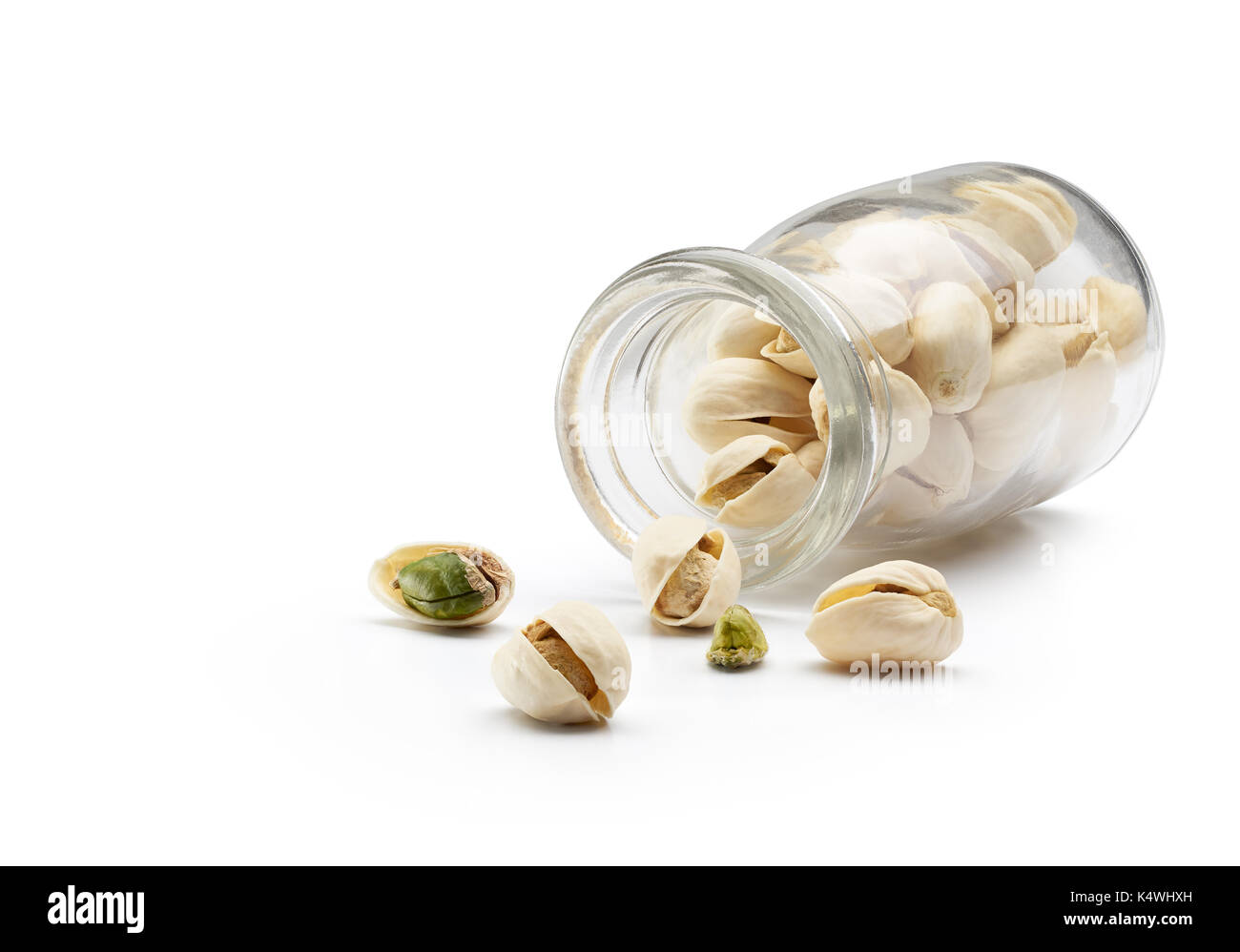 Pistachio Nuts pouring out from bottle isolated on white Stock Photo ...