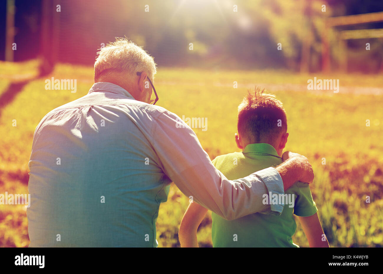grandfather and grandson hugging outdoors Stock Photo - Alamy