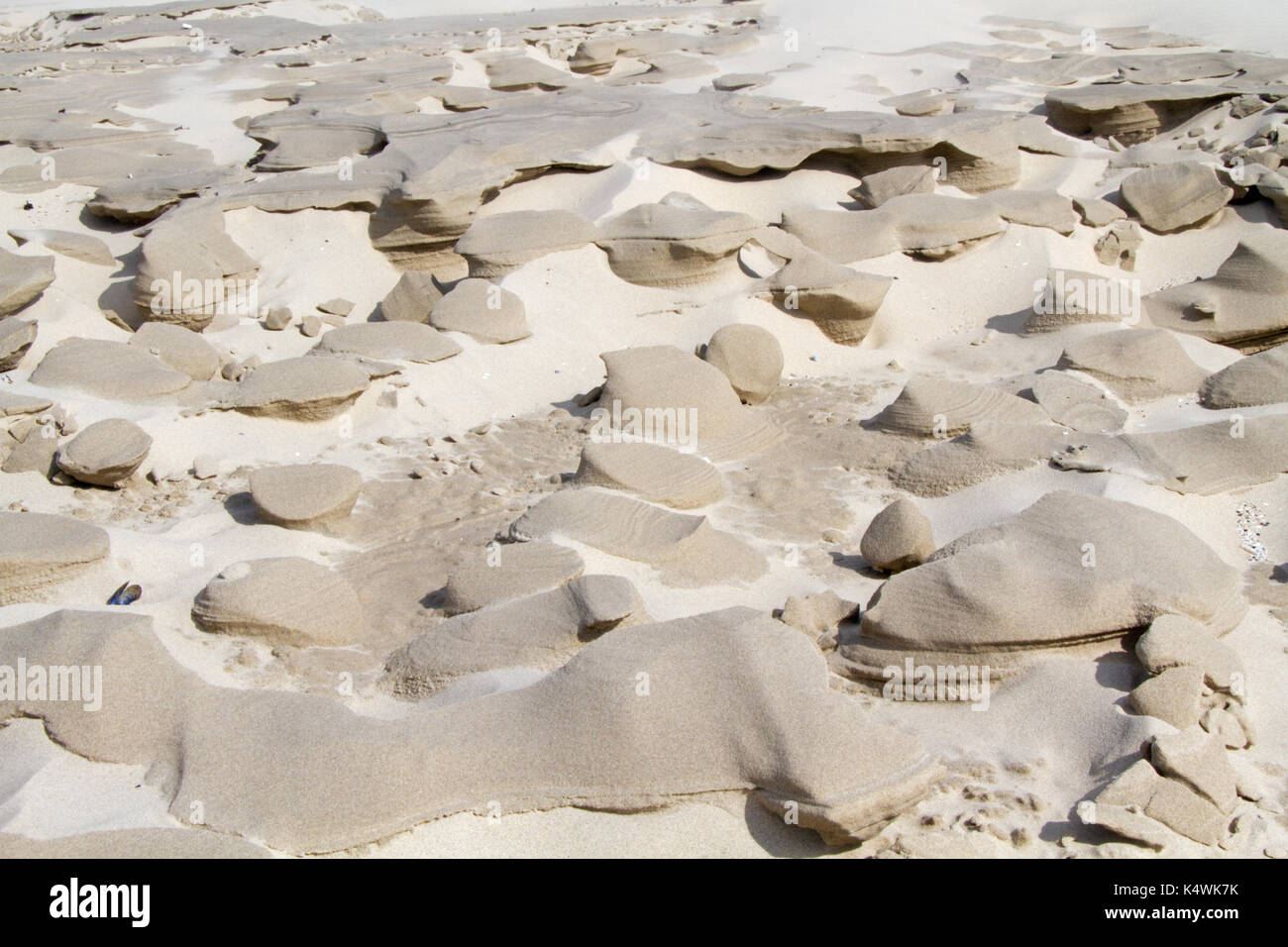 Forming of strange shapes as the wet sand of a beach dries Stock Photo ...