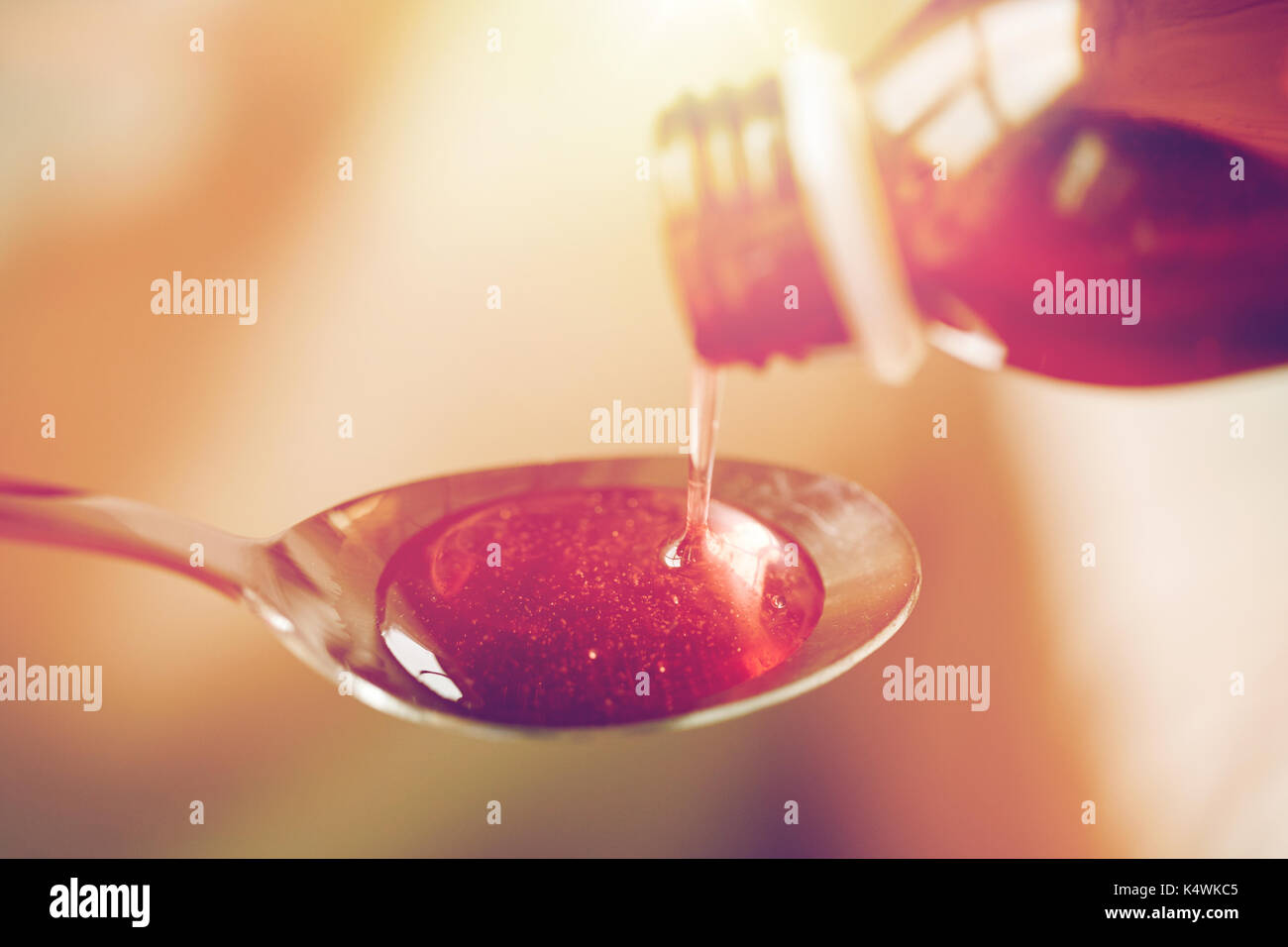 medication or antipyretic syrup and spoon Stock Photo - Alamy