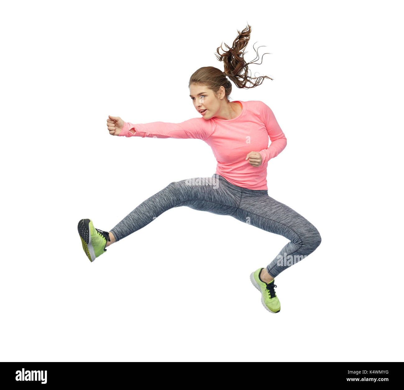 happy sporty young woman jumping in fighting pose Stock Photo - Alamy