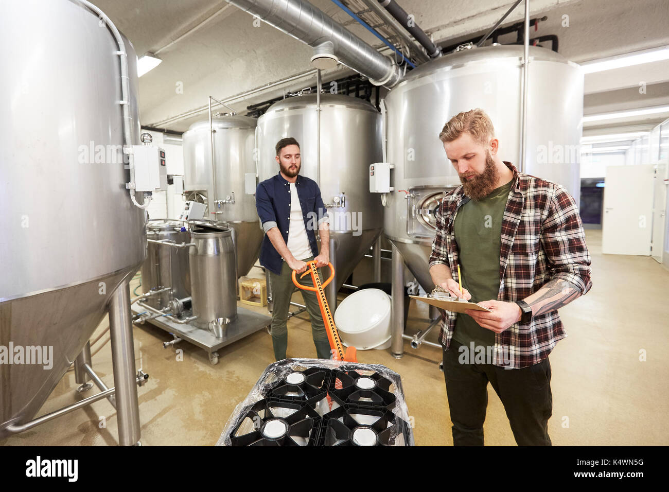 men with beer kegs on loader at craft brewery Stock Photo - Alamy