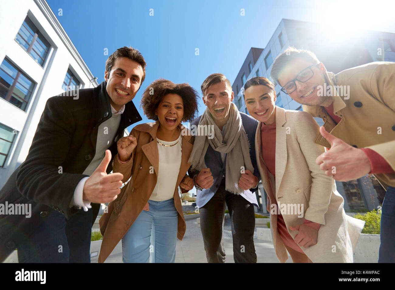 group of people showing thumbs up in city Stock Photo - Alamy