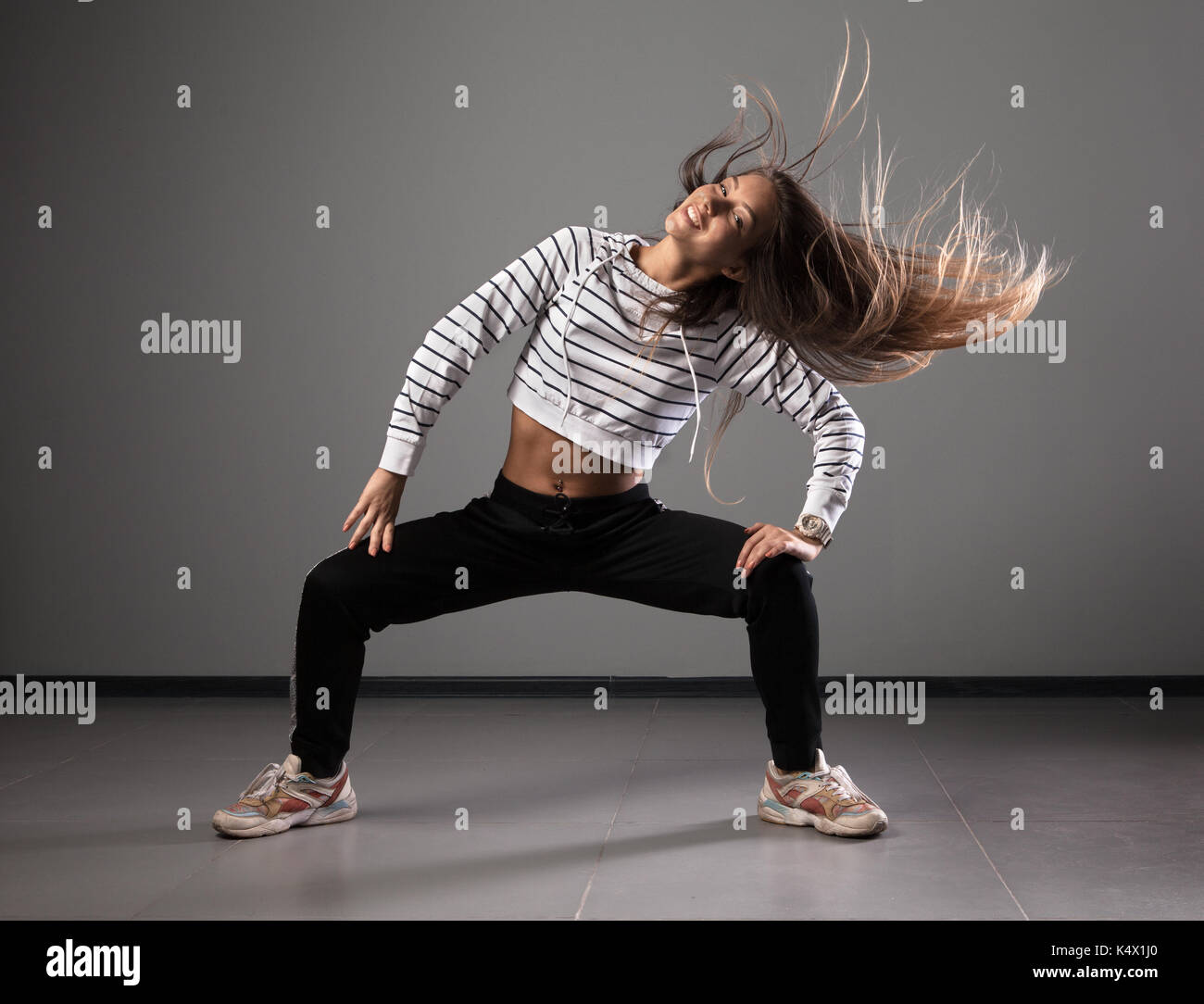 modern young beautiful dancer posing on a studio background Stock Photo ...