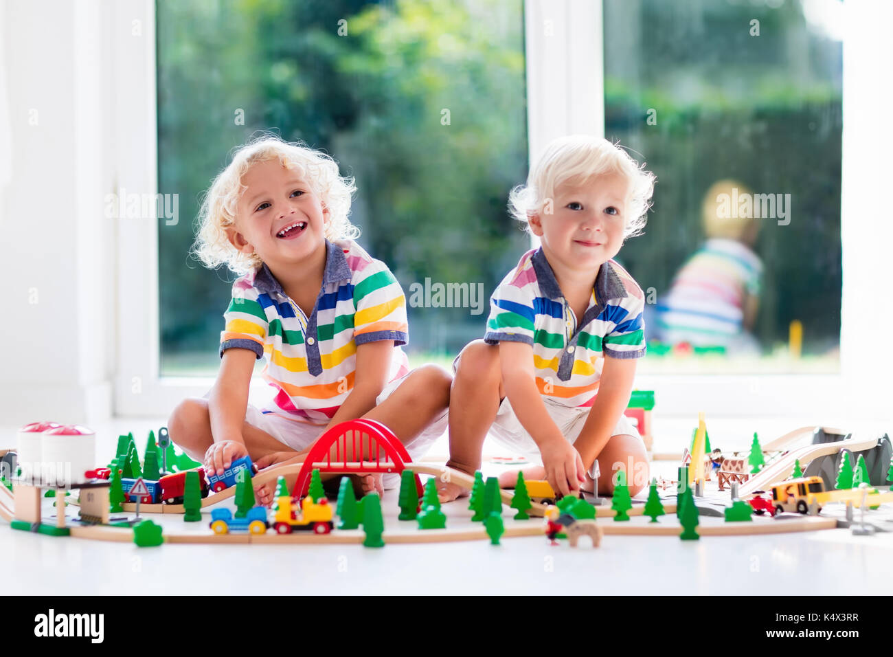 Kids play with toy train railway. Children playing with wooden trains ...
