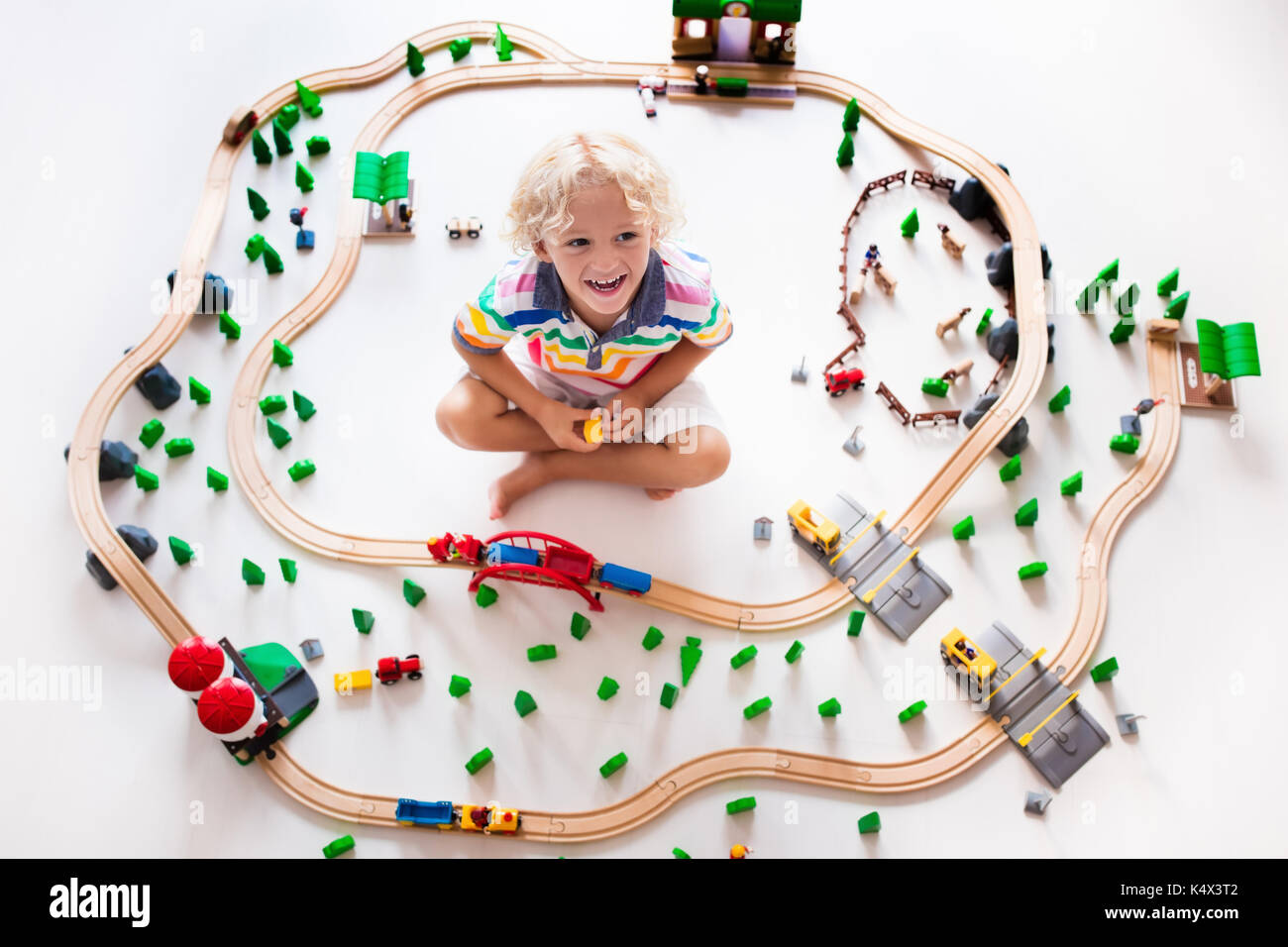 Kids play with toy train railway. Child playing with wooden trains ...