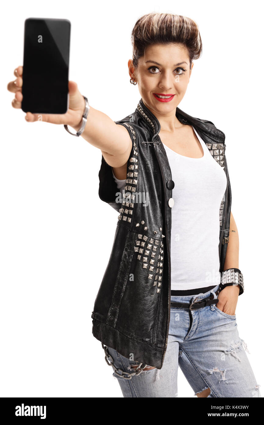 Punk girl showing a phone to the camera isolated on white background ...