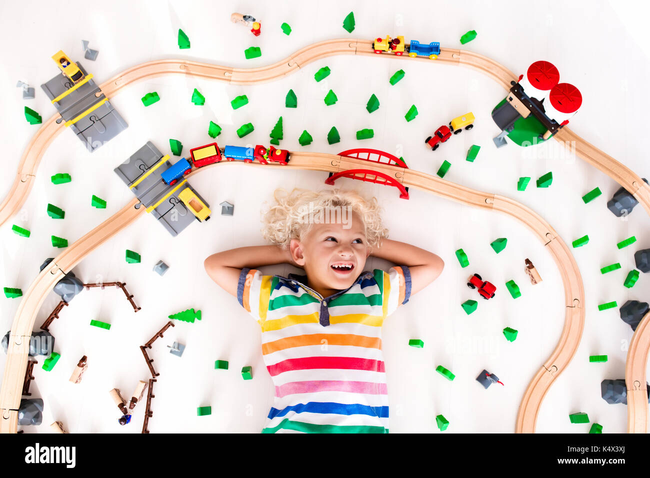 Kids play with toy train railway. Child playing with wooden trains ...