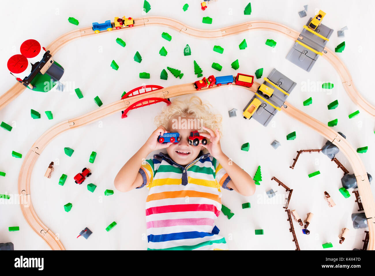 Kids play with toy train railway. Child playing with wooden trains ...