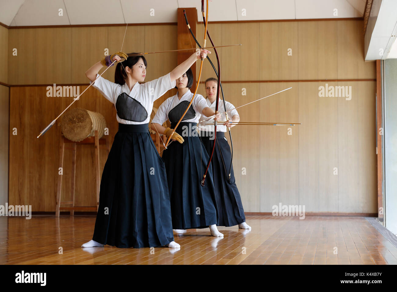 Multi-ethnic group of traditional archery athletes practicing Stock ...