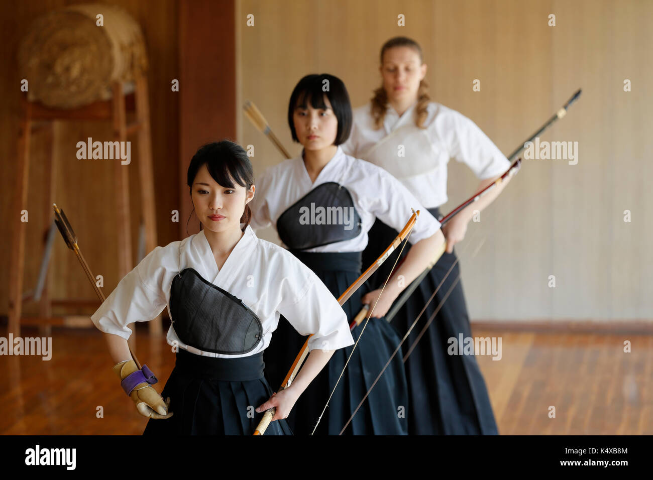 Multi-ethnic group of traditional archery athletes practicing Stock ...