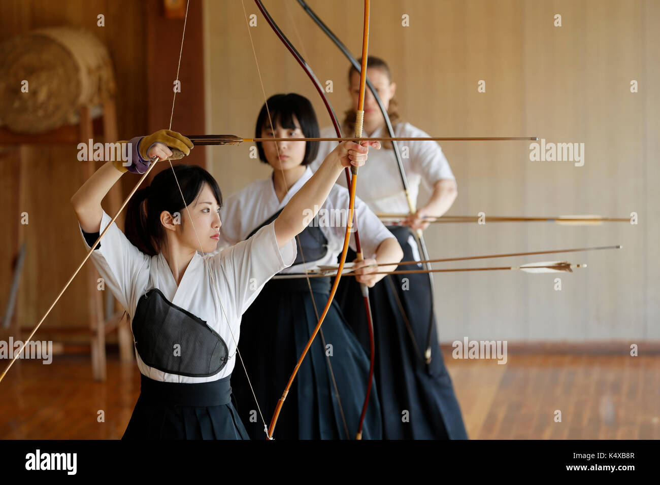 Multi-ethnic group of traditional archery athletes practicing Stock ...