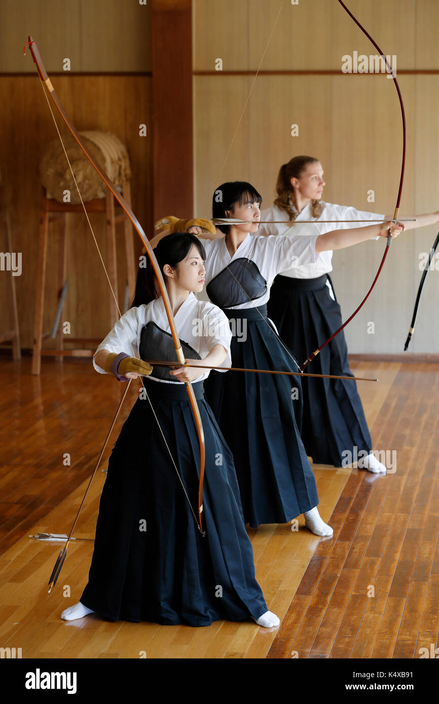Multi-ethnic group of traditional archery athletes practicing Stock ...